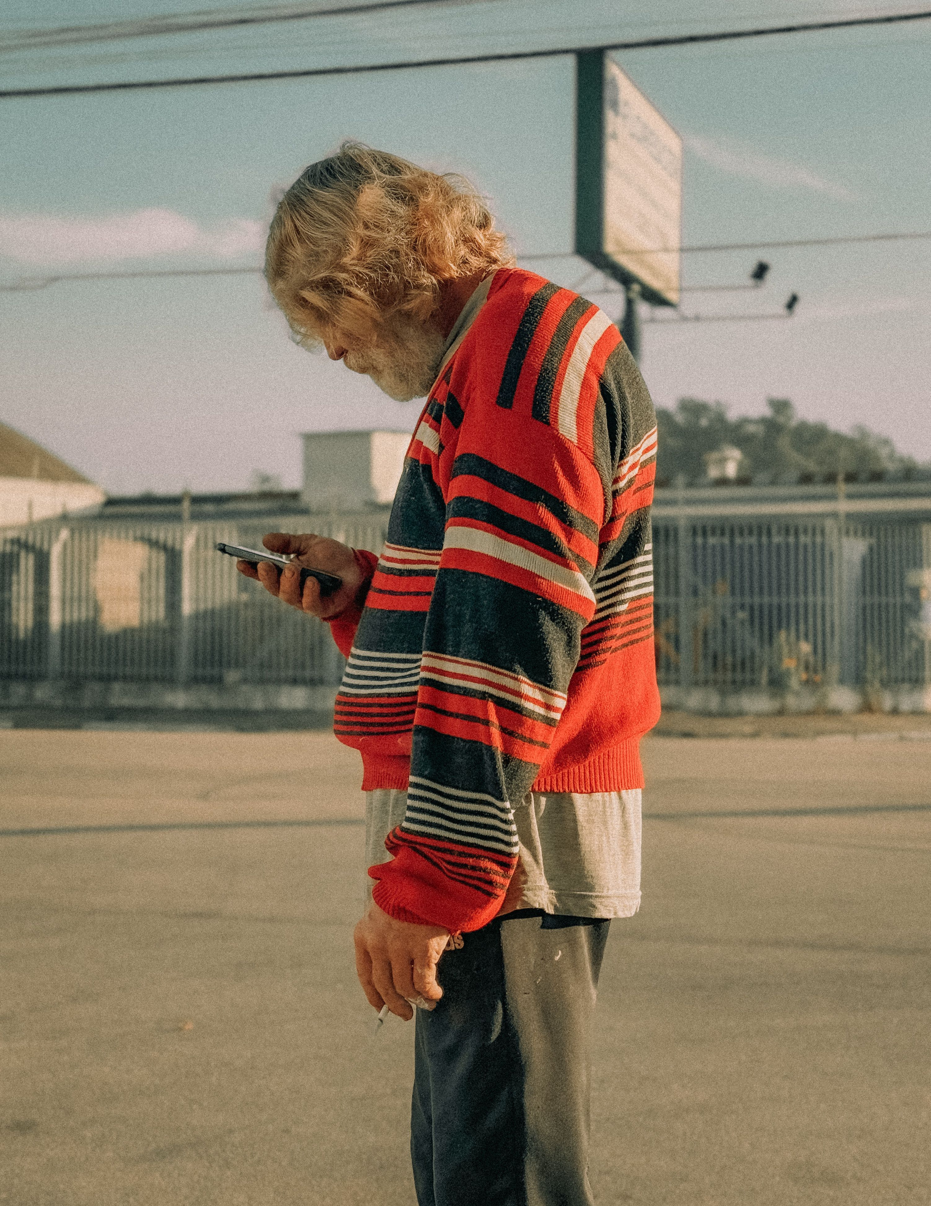 Man seeing cell phone and smoking a cigarette. · Free Stock Photo