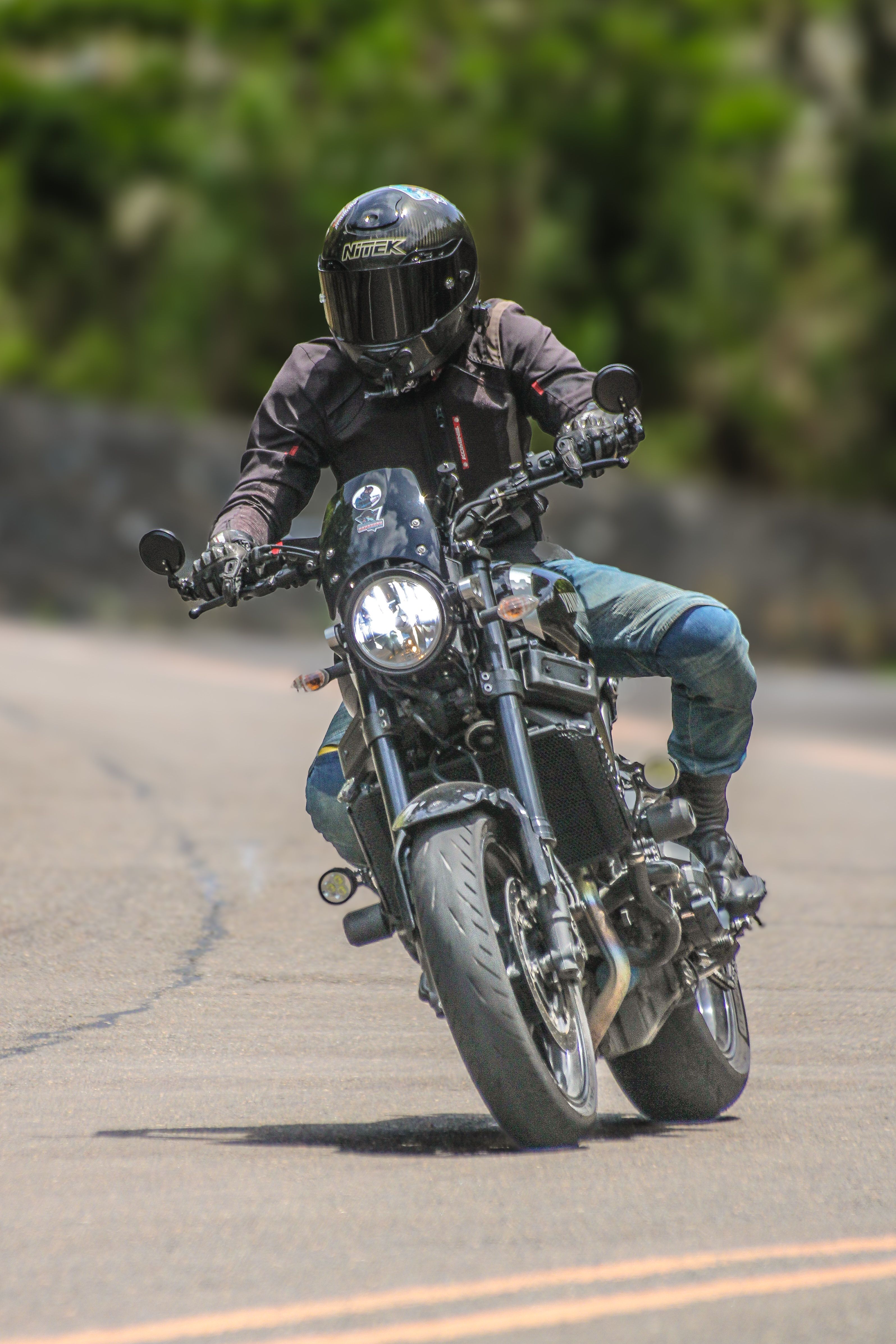 Man Riding on Ducati Scrambler Motorcycle on Road · Free Stock Photo