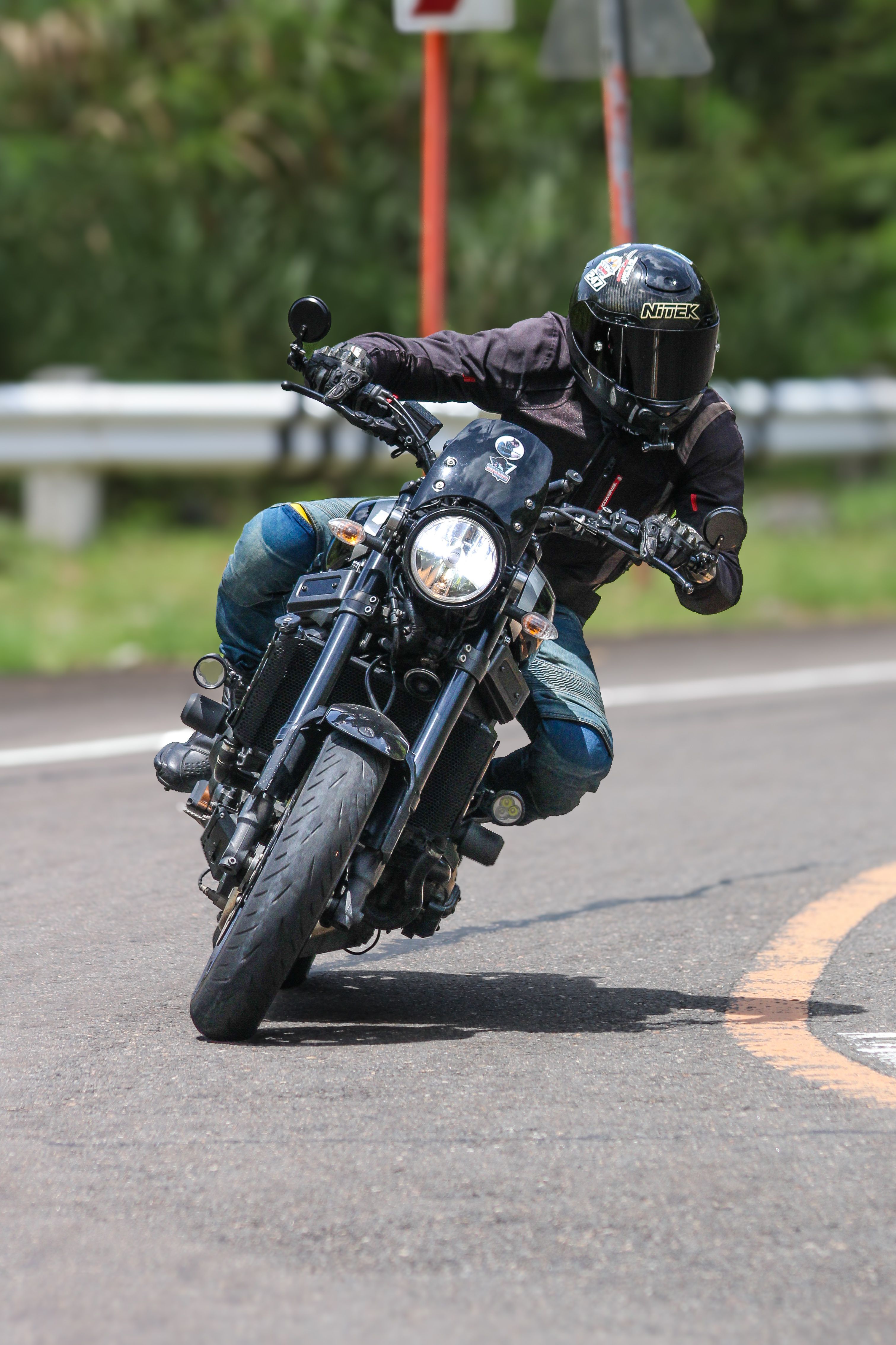Motorcyclist with Helmet Riding on Road Curve · Free Stock Photo