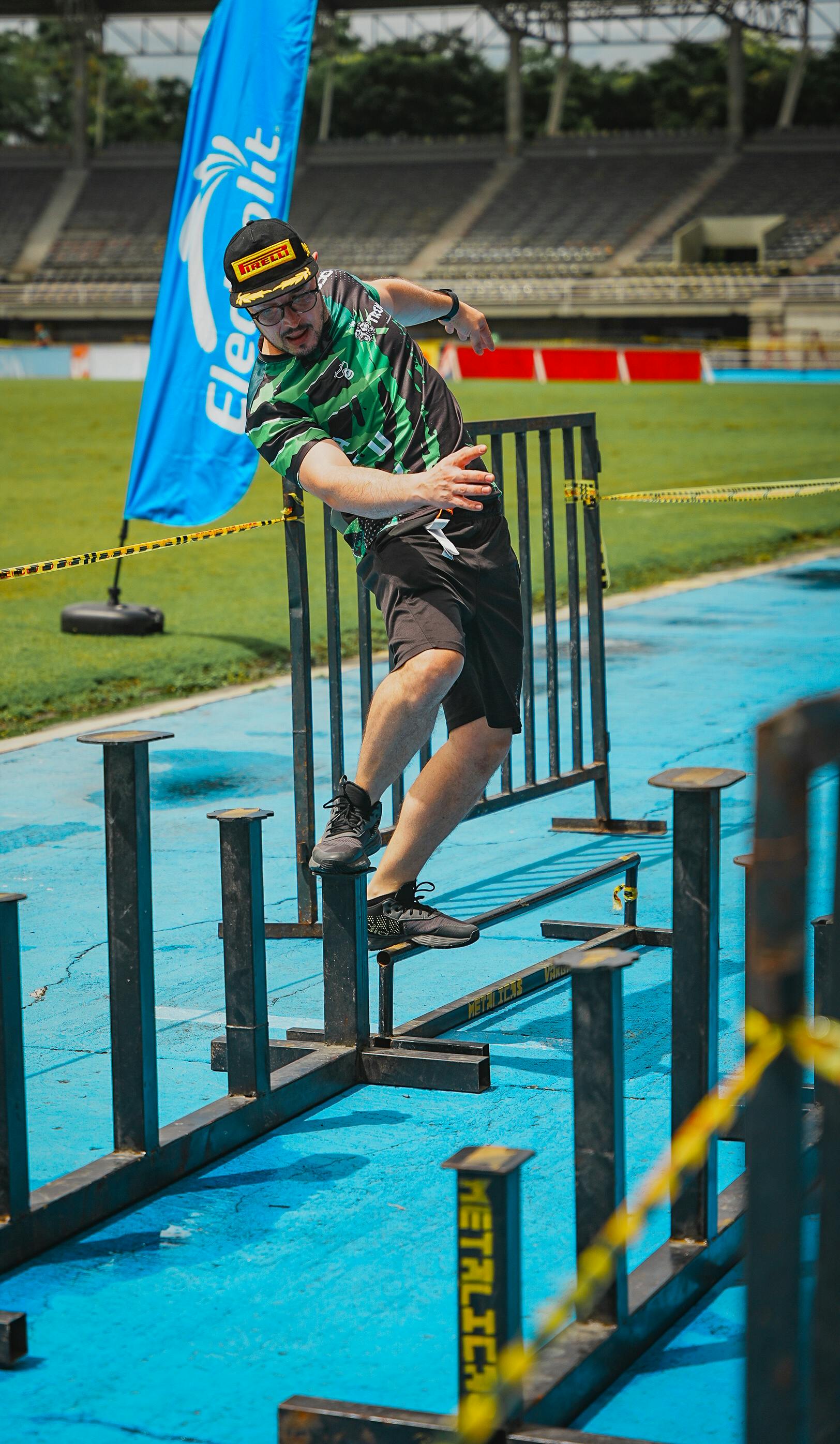 Man in Cap in Obstacle Course at Stadium · Free Stock Photo