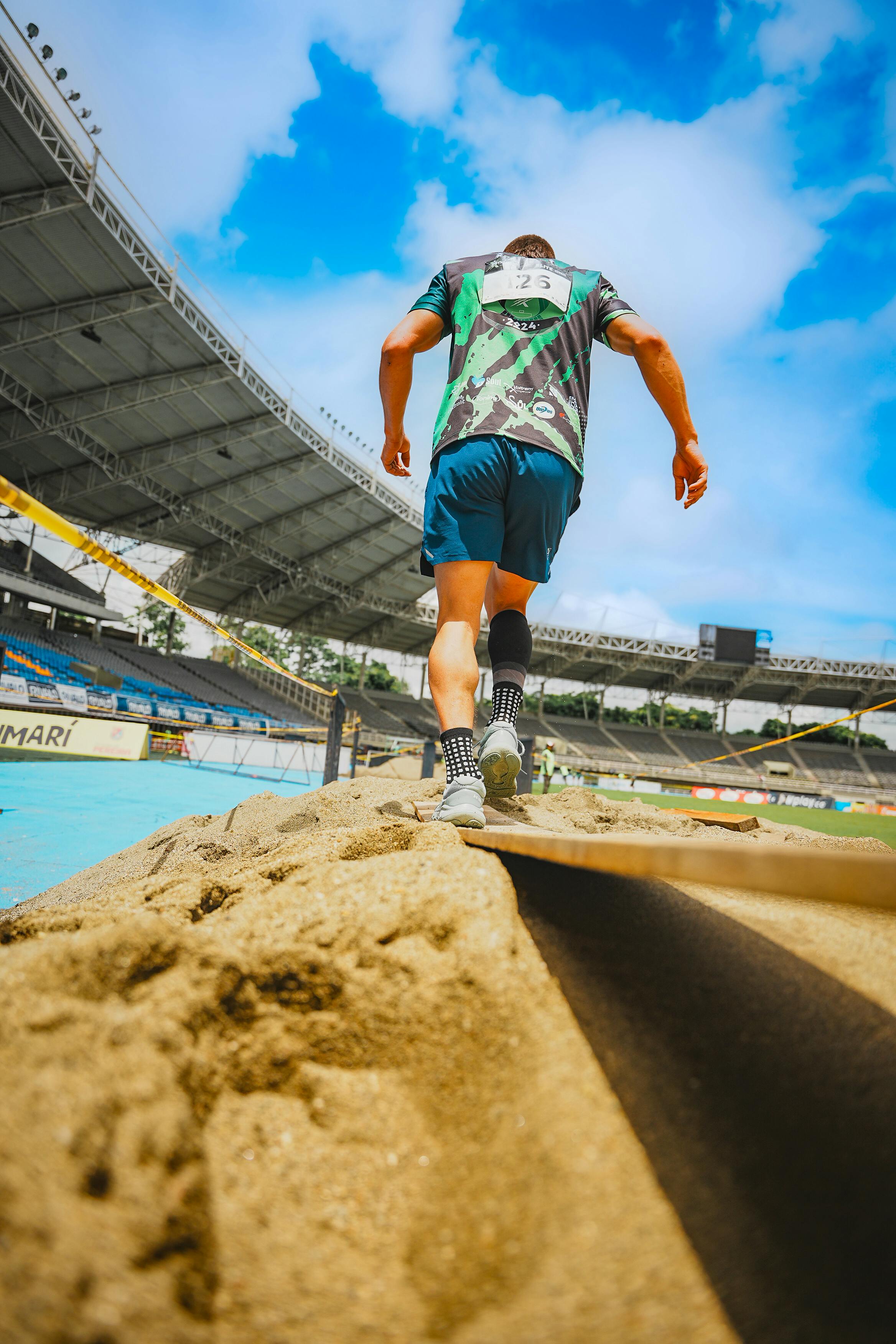 Back View of Man Athlete on Obstacle Course on Stadium · Free Stock Photo