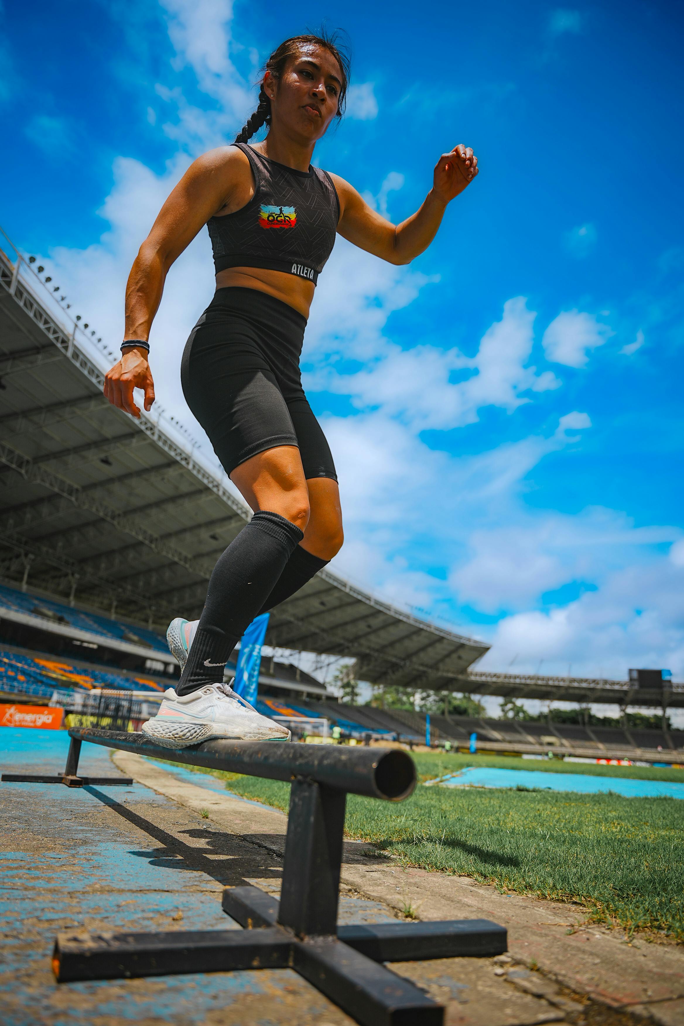 Woman Balancing on Black Tube in Obstacle Course · Free Stock Photo