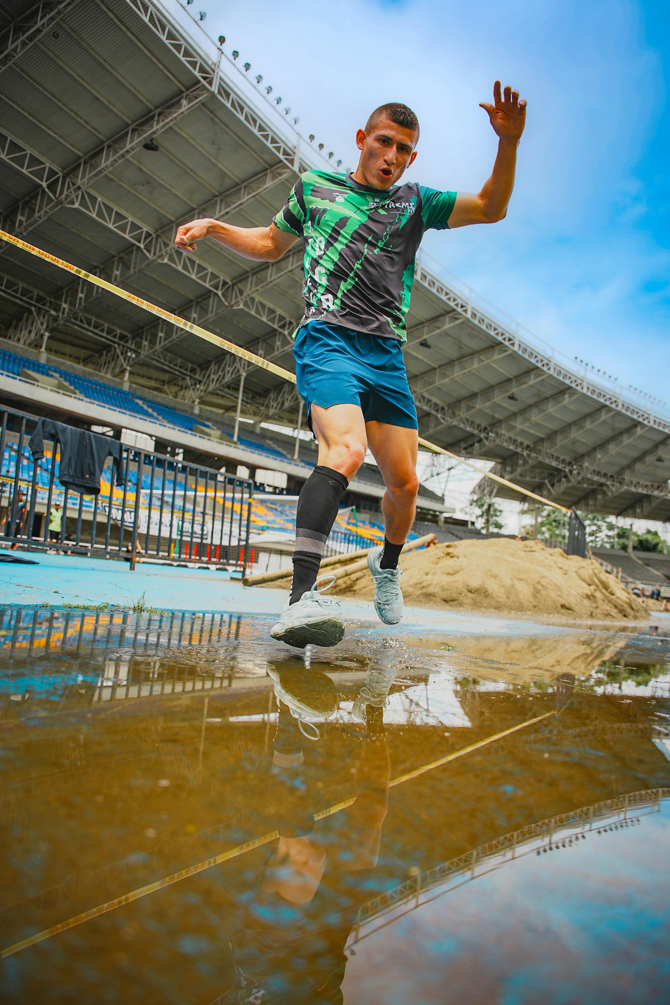 Man Running Through Puddle at Steeplechase · Free Stock Photo