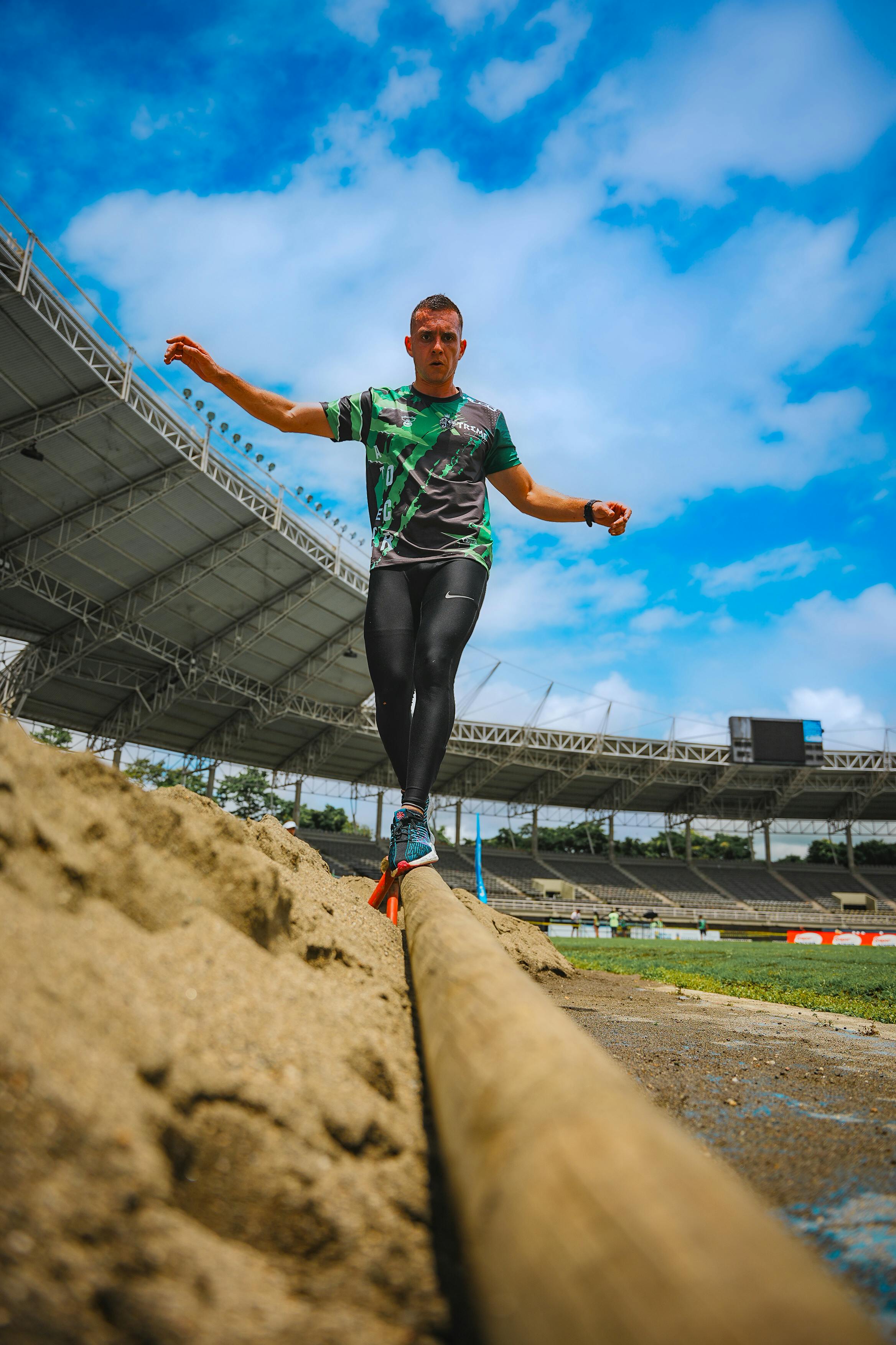 Man Balancing on Tube in Obstacle Course · Free Stock Photo