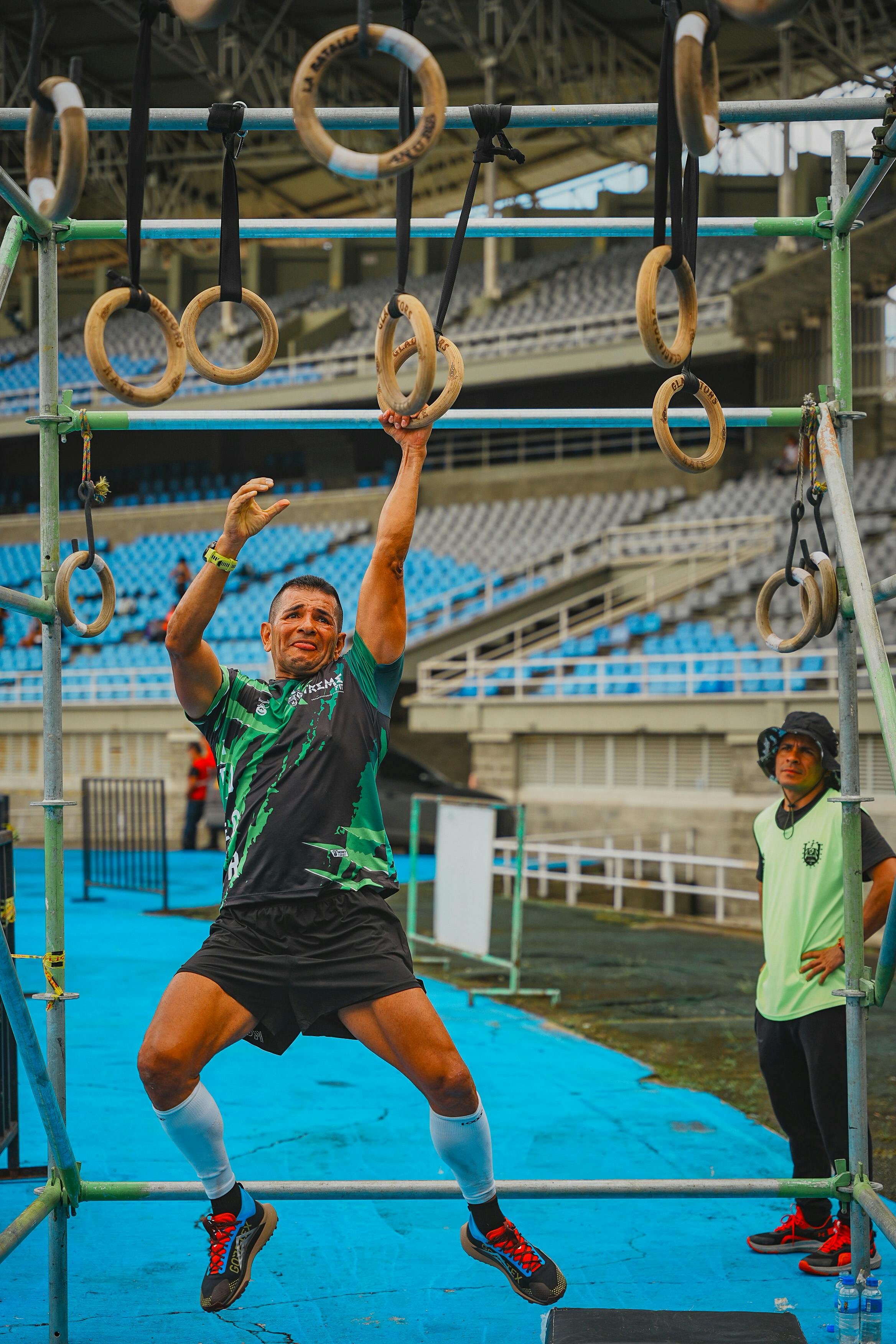 Man Athlete Hanging From Gymnastics Rings Training on Stadium · Free ...