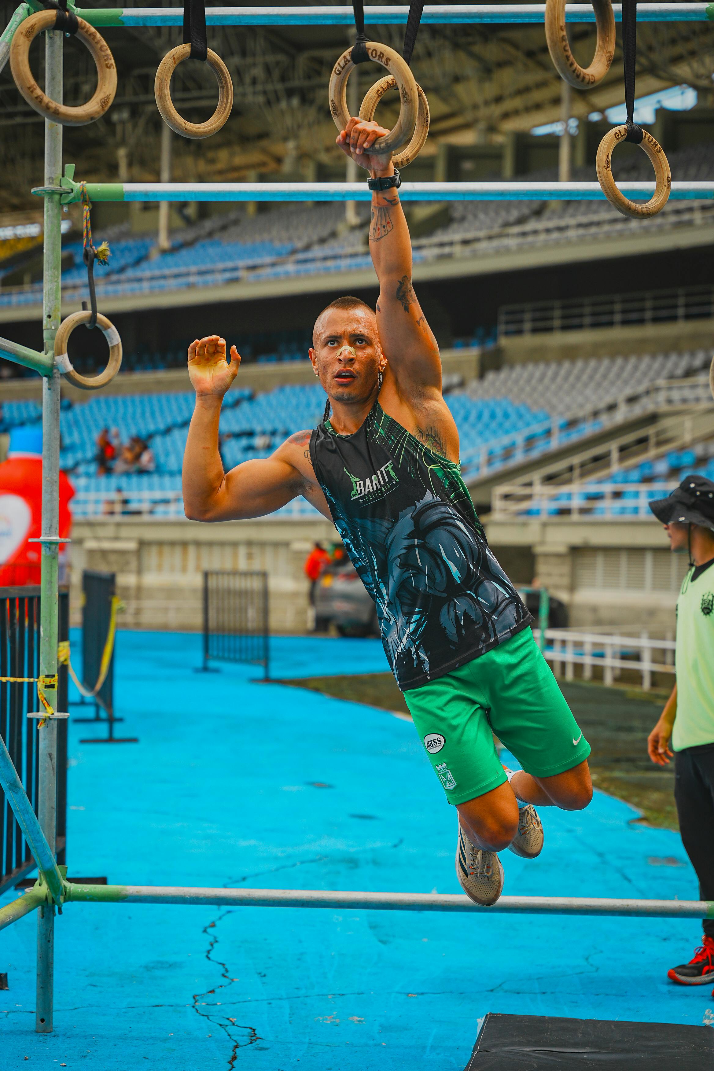 Man Hanging on Rings in Obstacle Course · Free Stock Photo