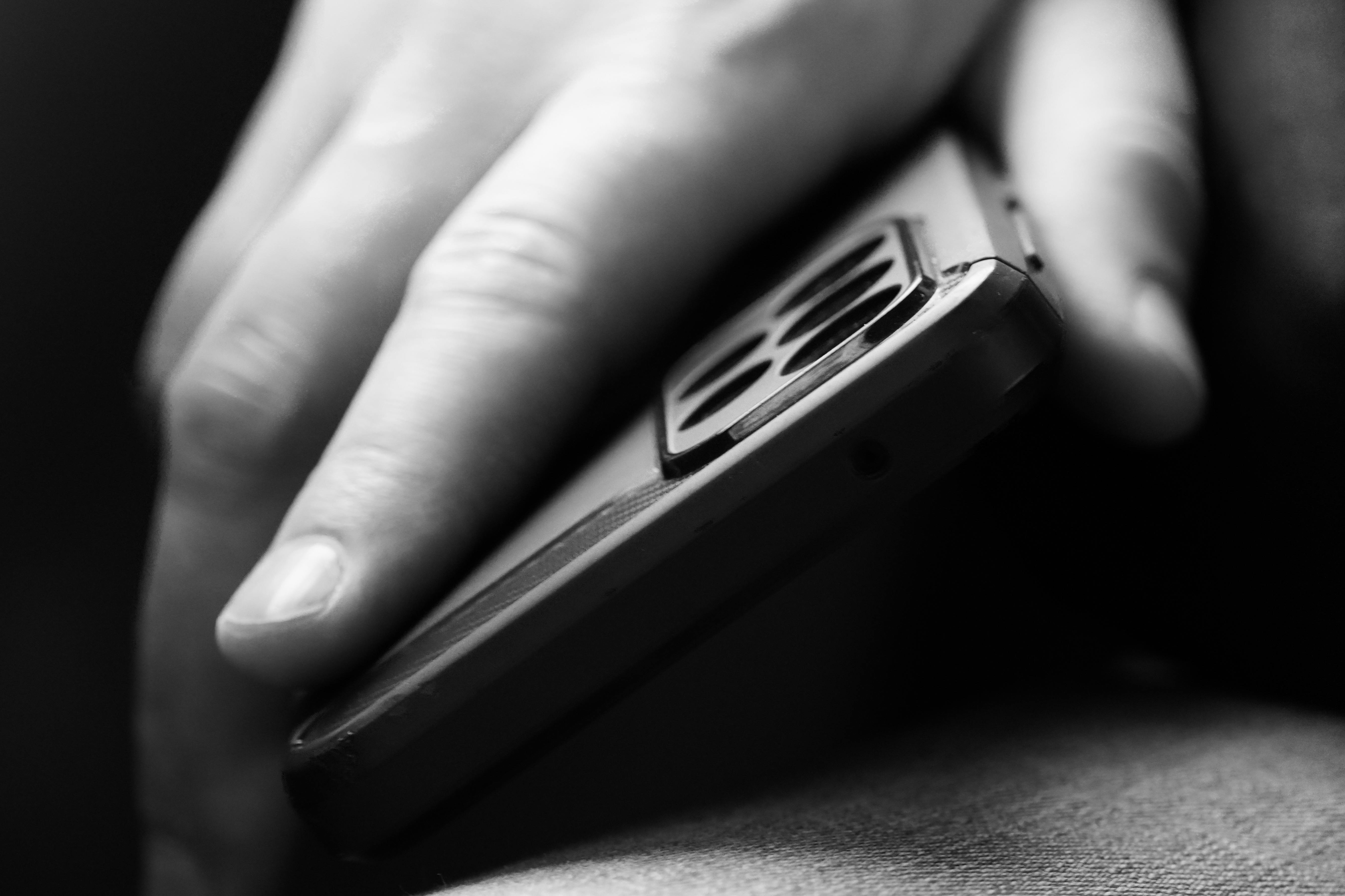 A person holding a cell phone in their hand · Free Stock Photo