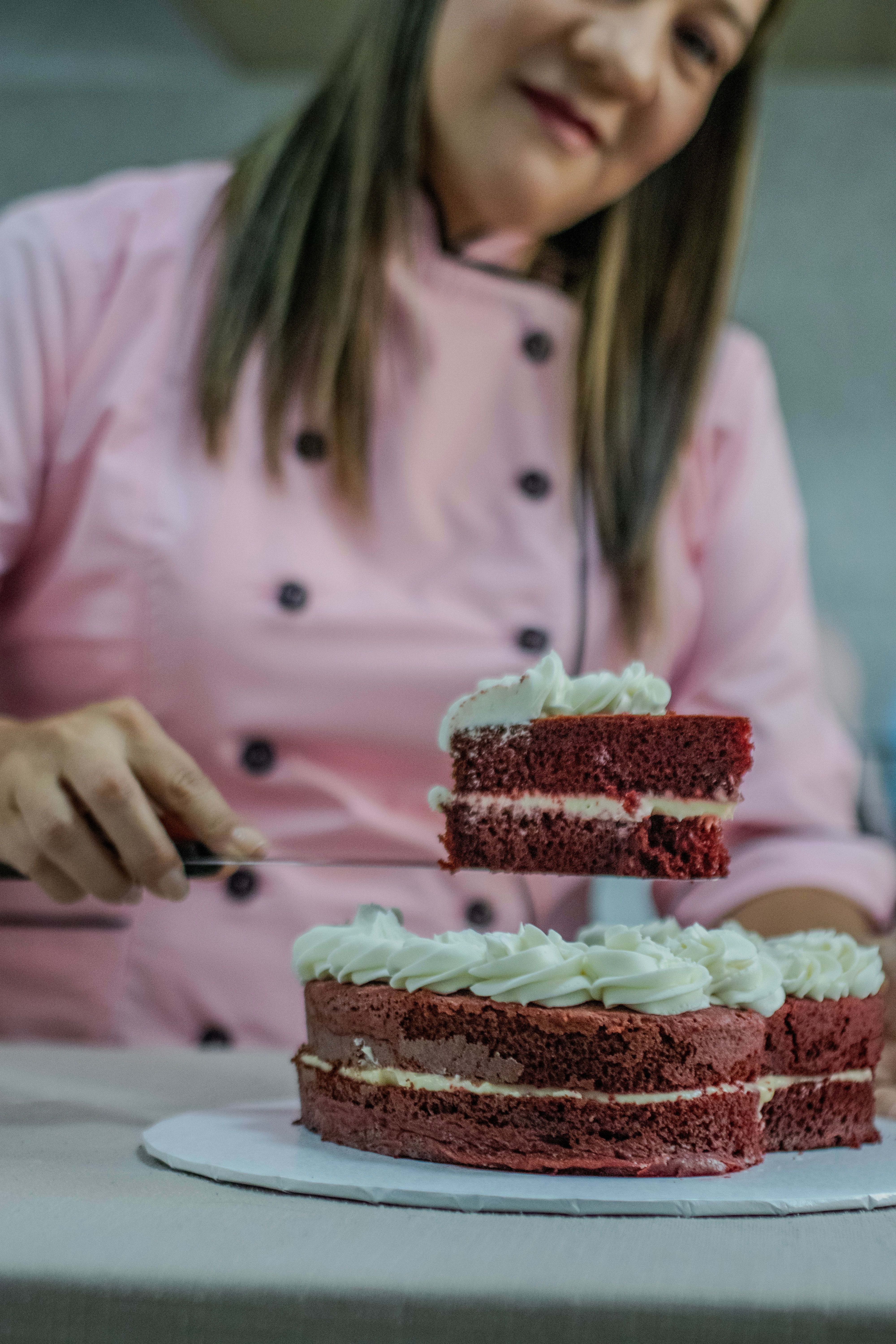 Person Putting an Icing on Top of a Cake Slice · Free Stock Photo