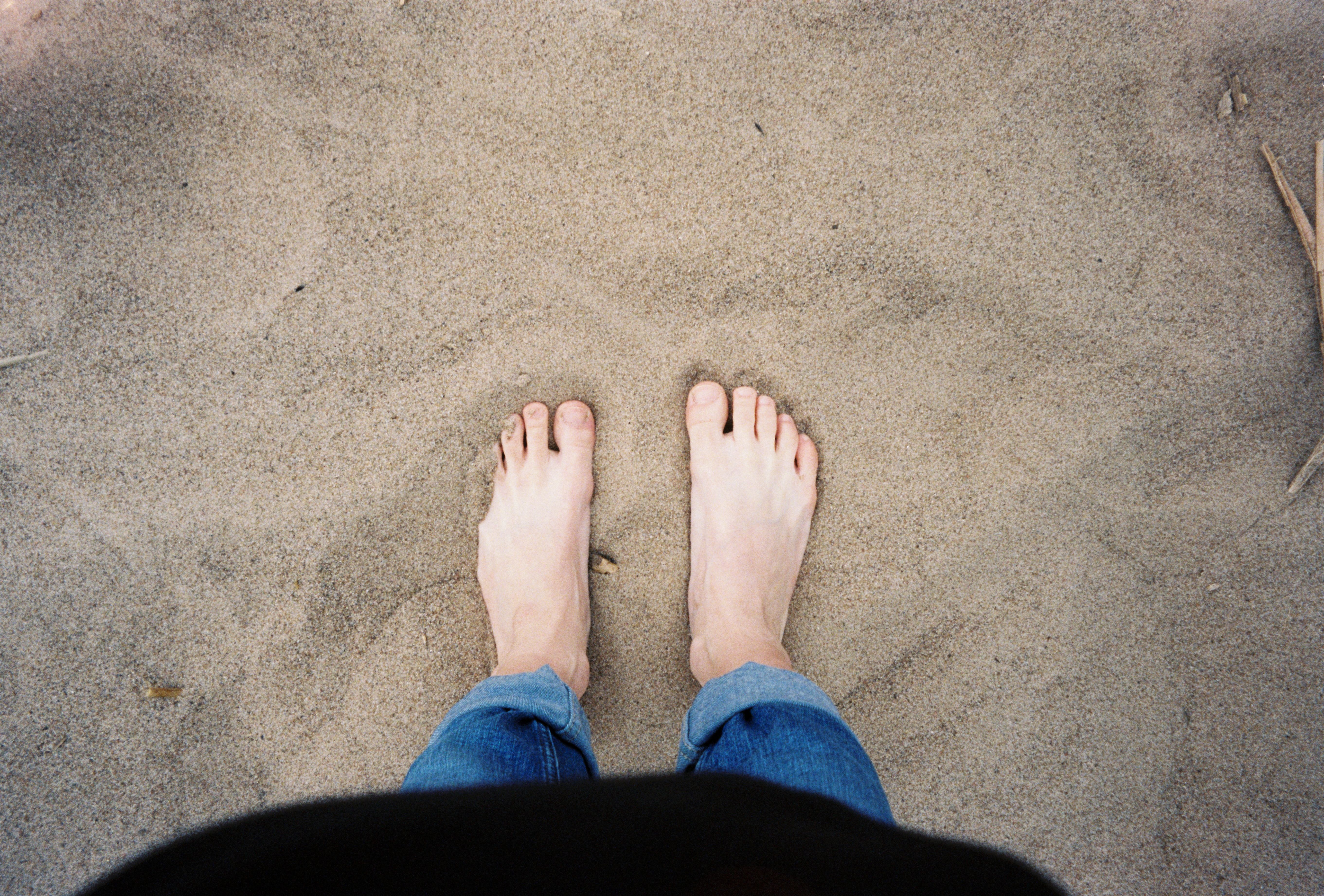 A person's feet in the sand · Free Stock Photo