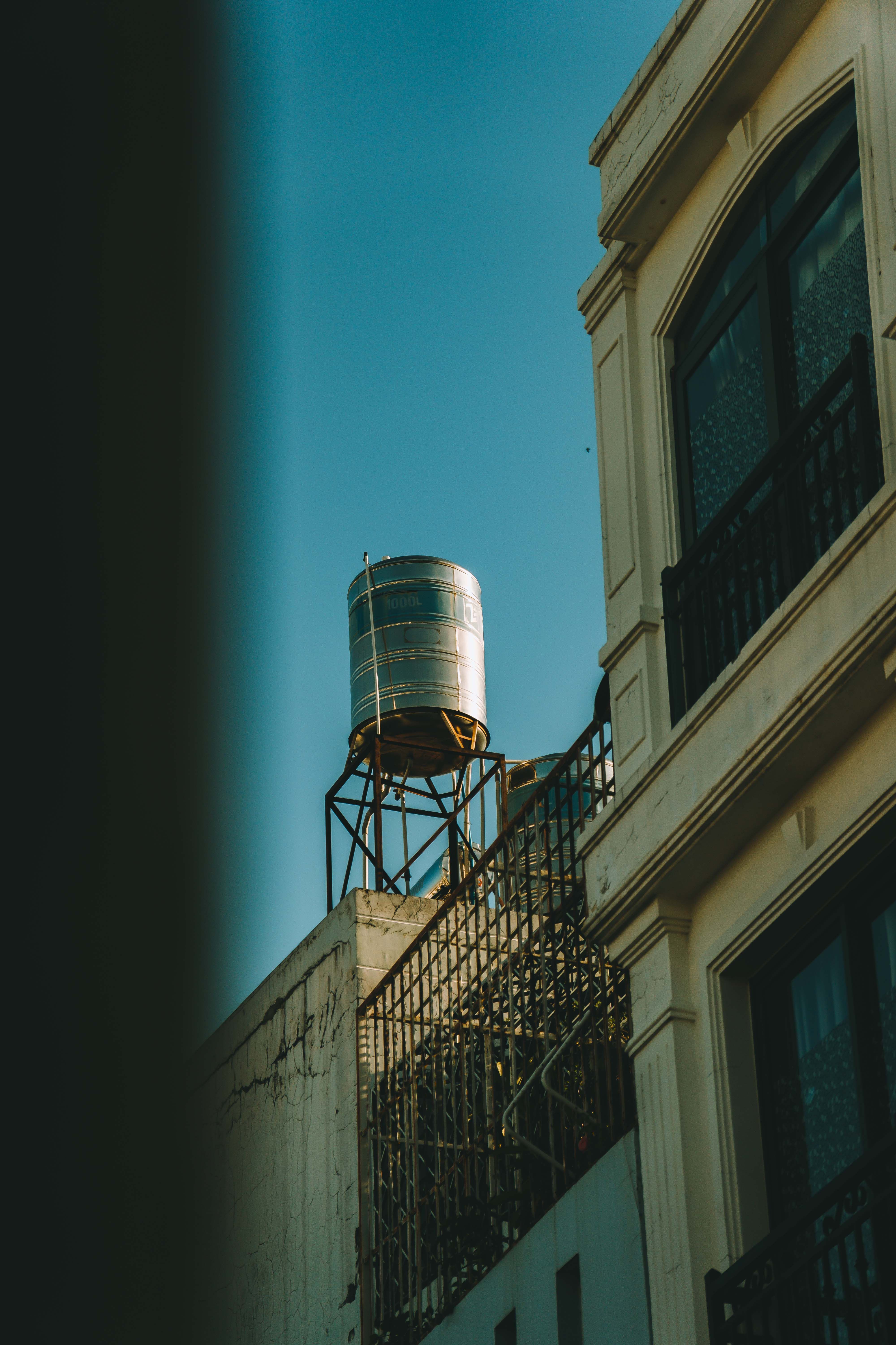 A water tower is seen in the distance · Free Stock Photo