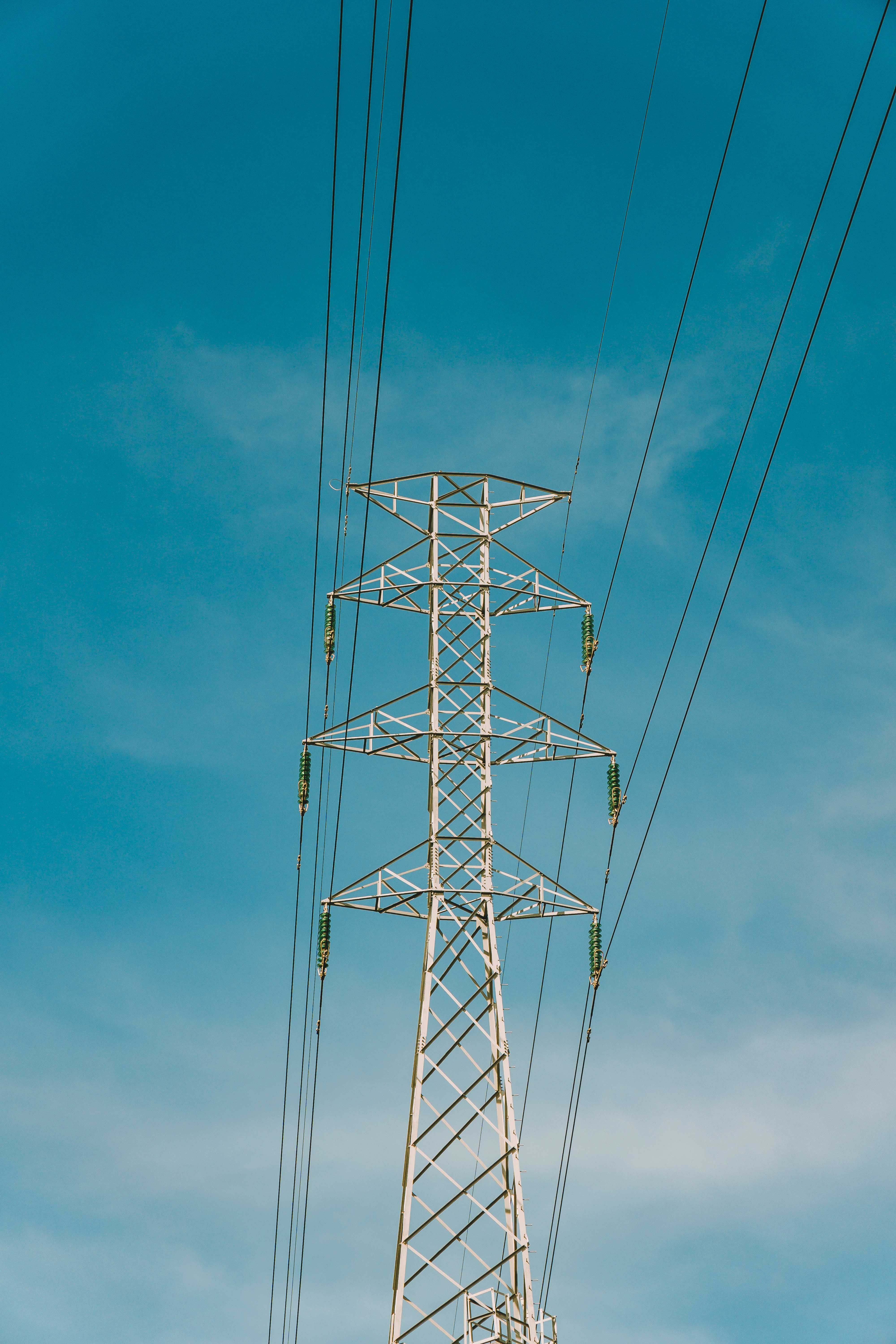 Photo of a Transmission Tower Under a Blue Sky · Free Stock Photo