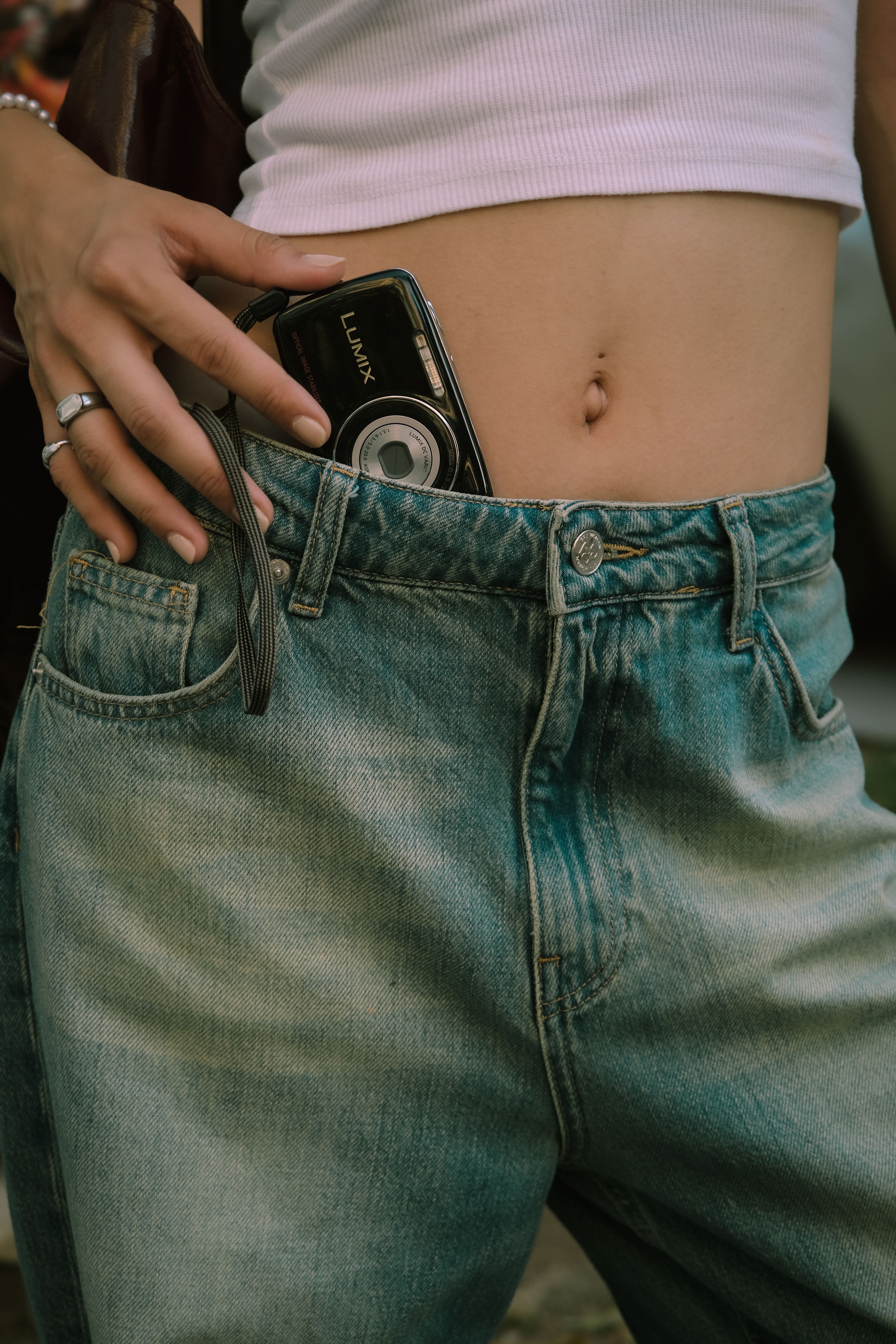 A woman with a camera in her jeans · Free Stock Photo