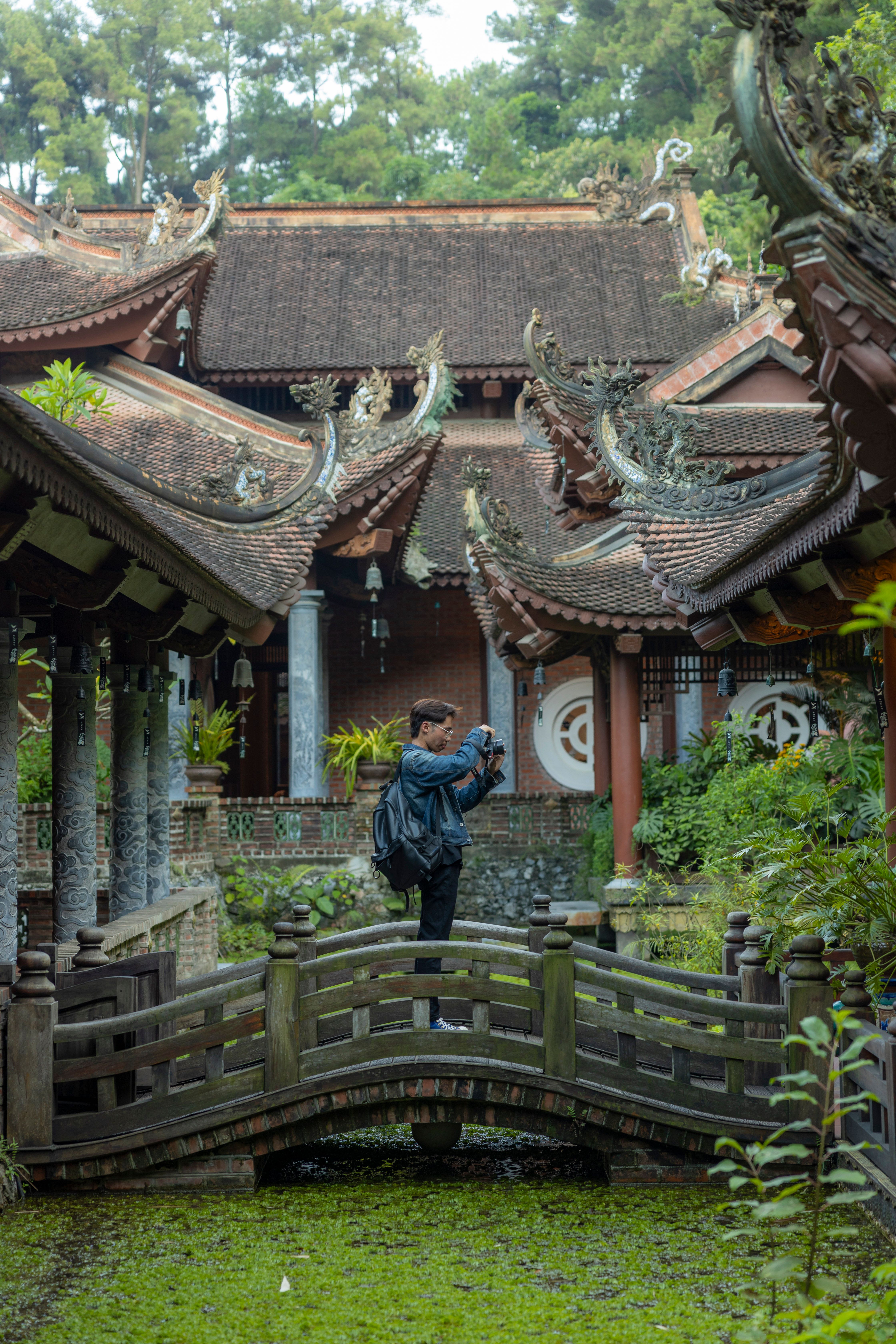 Man Standing at Buddhist Temple and Photographing · Free Stock Photo