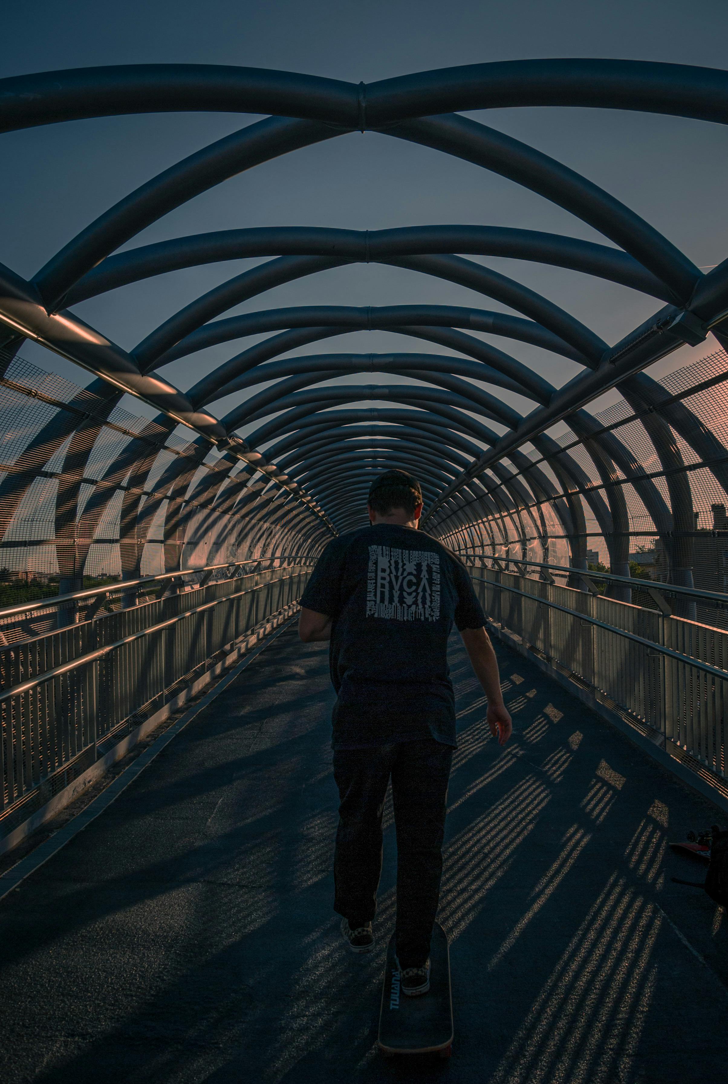Back View of Man Walking on Footbridge · Free Stock Photo