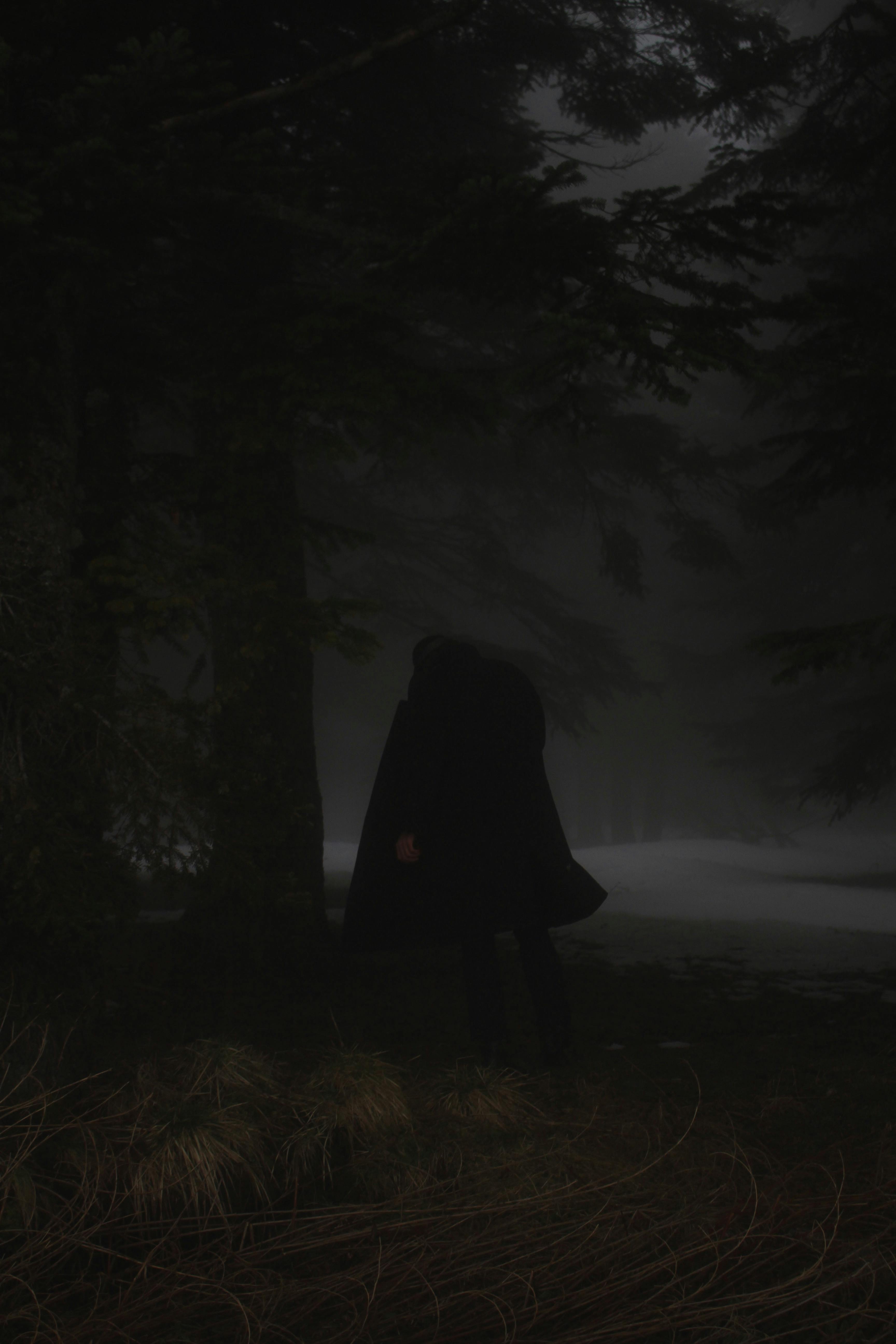 Low Angle View of Man Standing at Night · Free Stock Photo