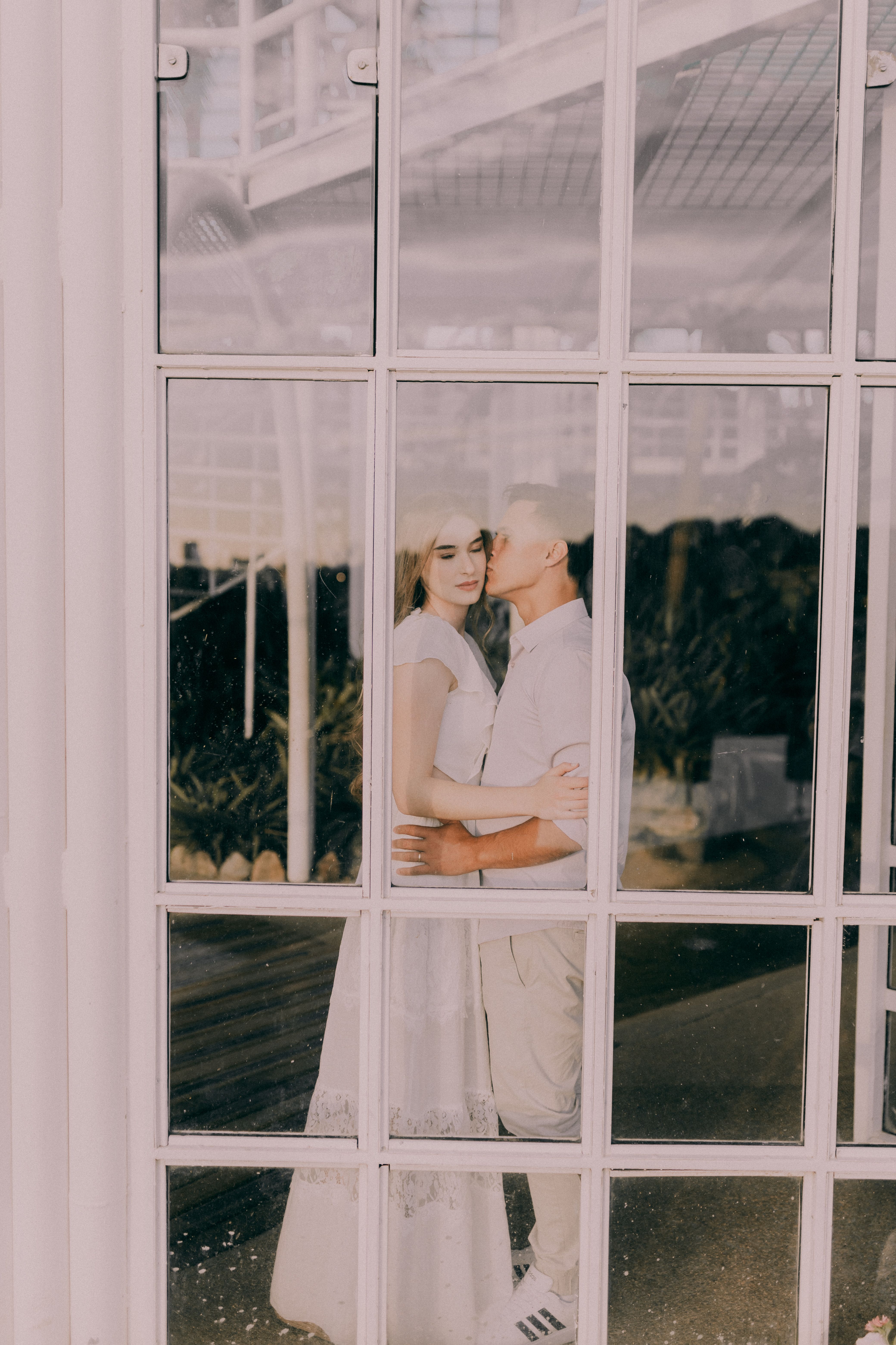 Couple Kissing behind Windows · Free Stock Photo