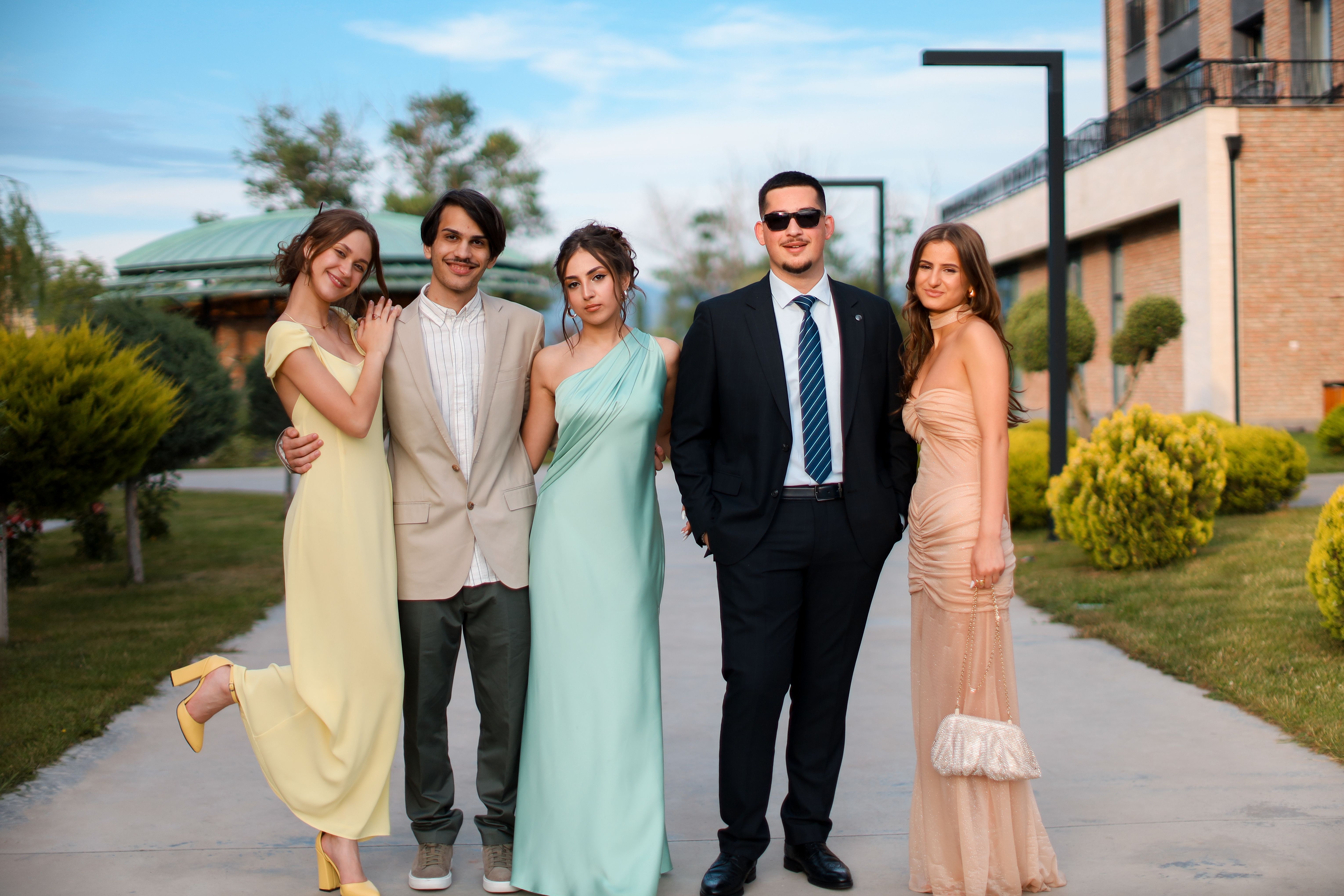 A group of people in formal attire posing for a photo · Free Stock Photo