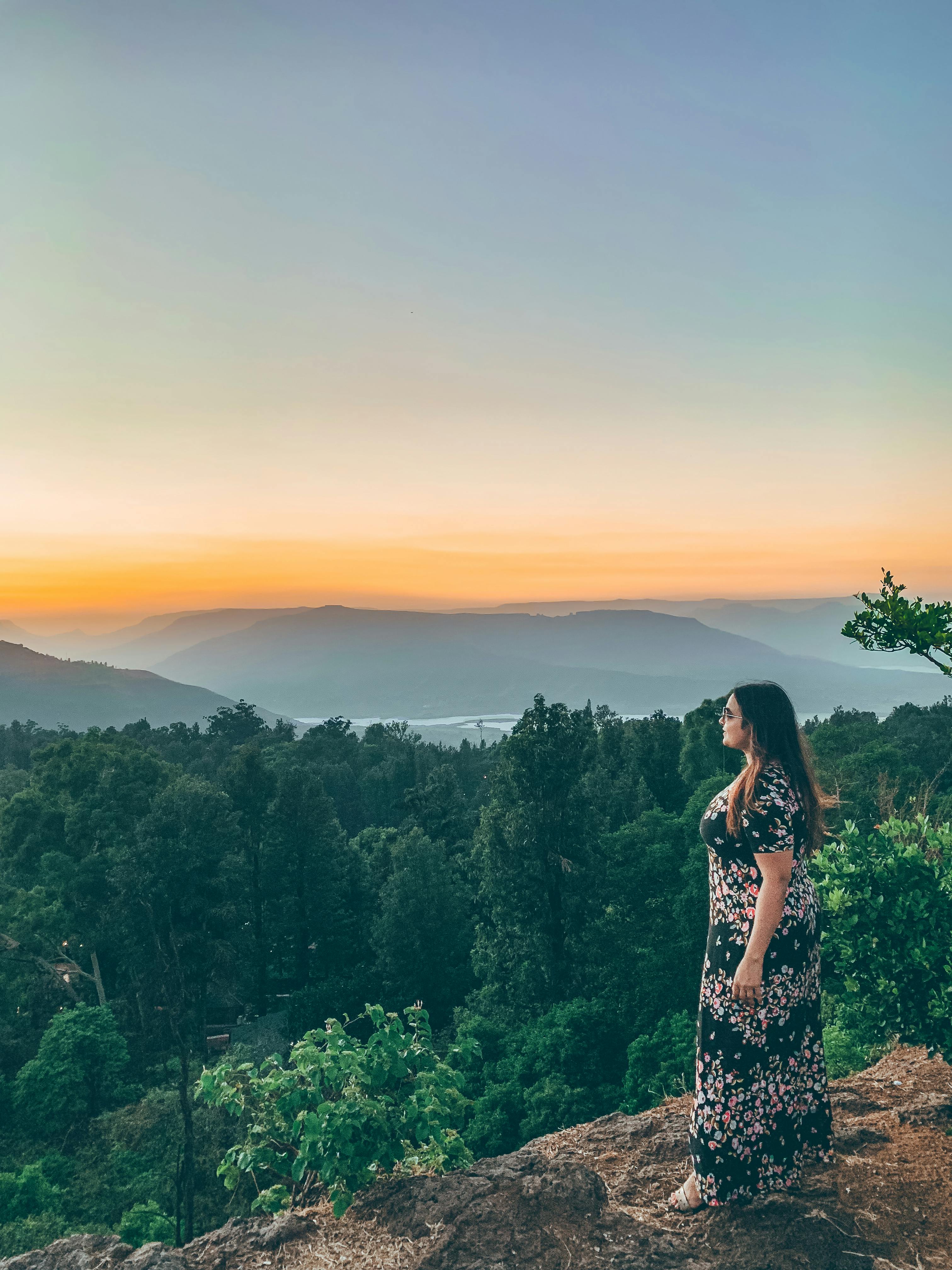 Woman Wearing Dress Standing on Cliff Overlooking Forest and Mountains ...