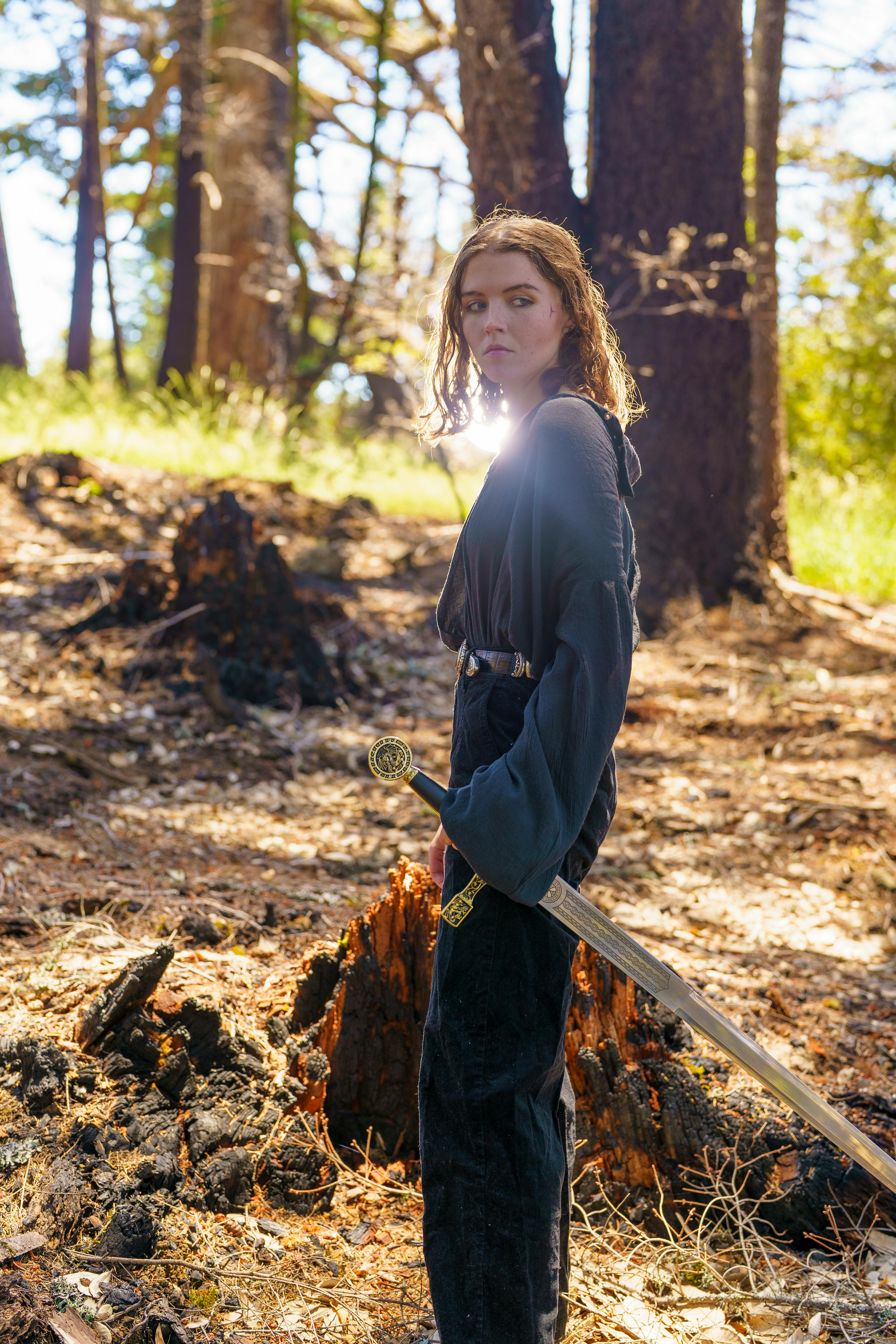Warrior Woman with Sword Standing in Forest · Free Stock Photo