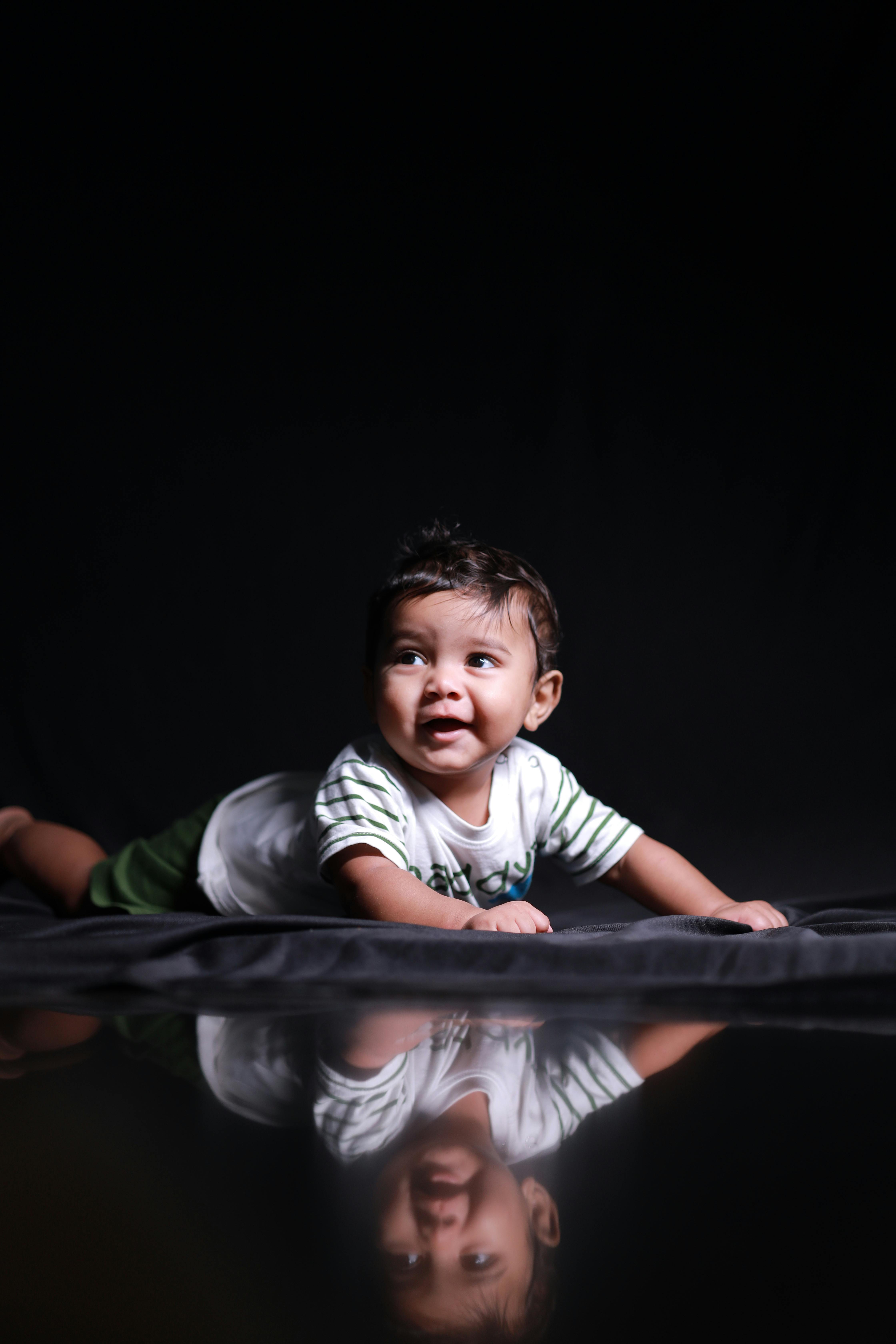 Cheerful Toddler Lying Face Down · Free Stock Photo