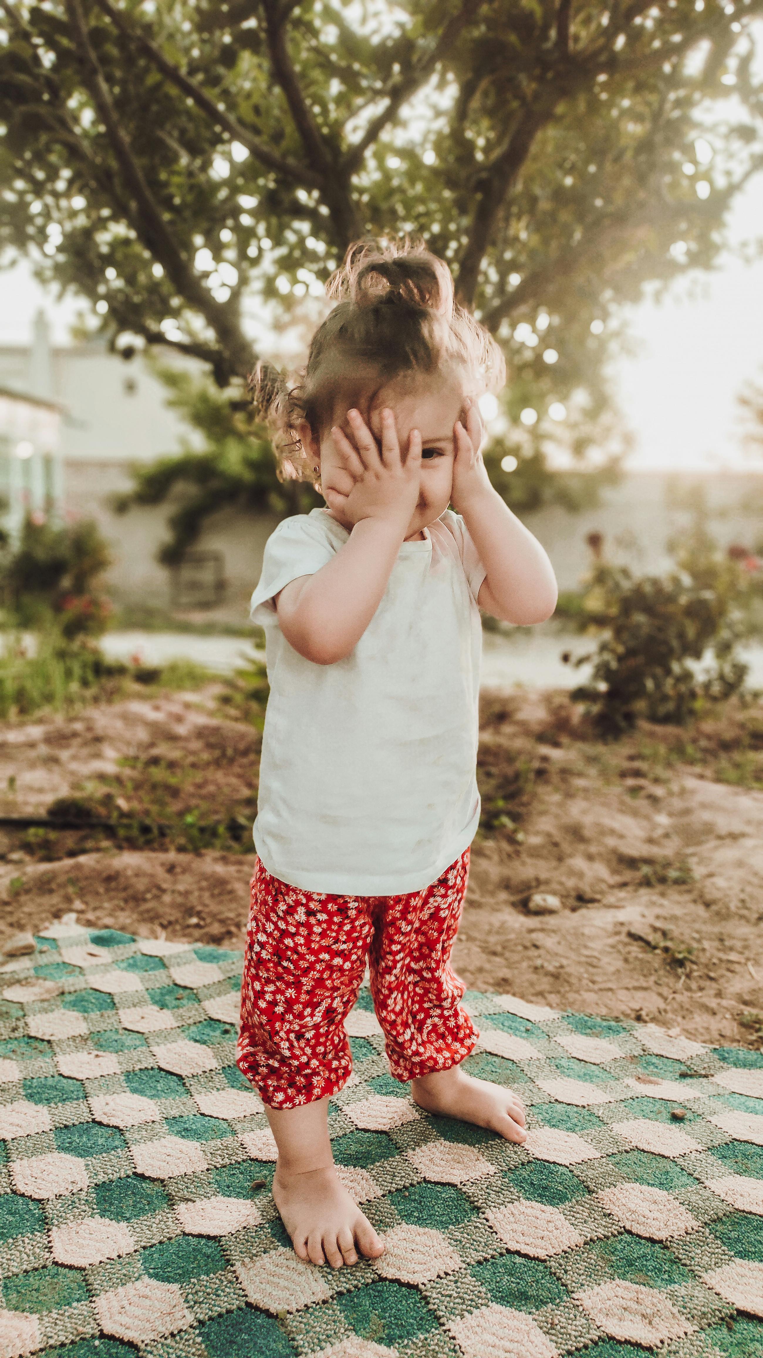 A Little Girl Standing in the Park · Free Stock Photo