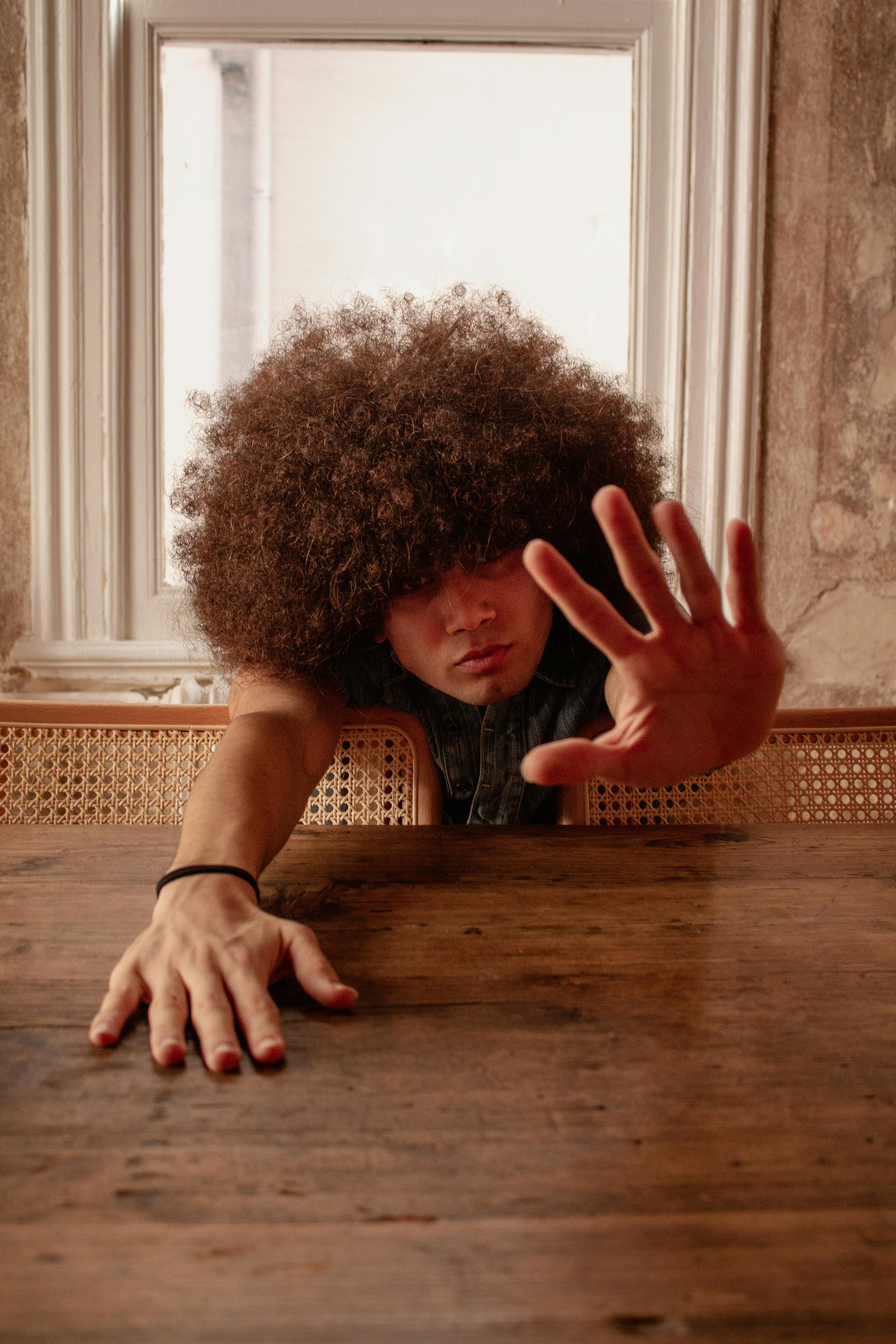 Man Keeping Hand over Table · Free Stock Photo