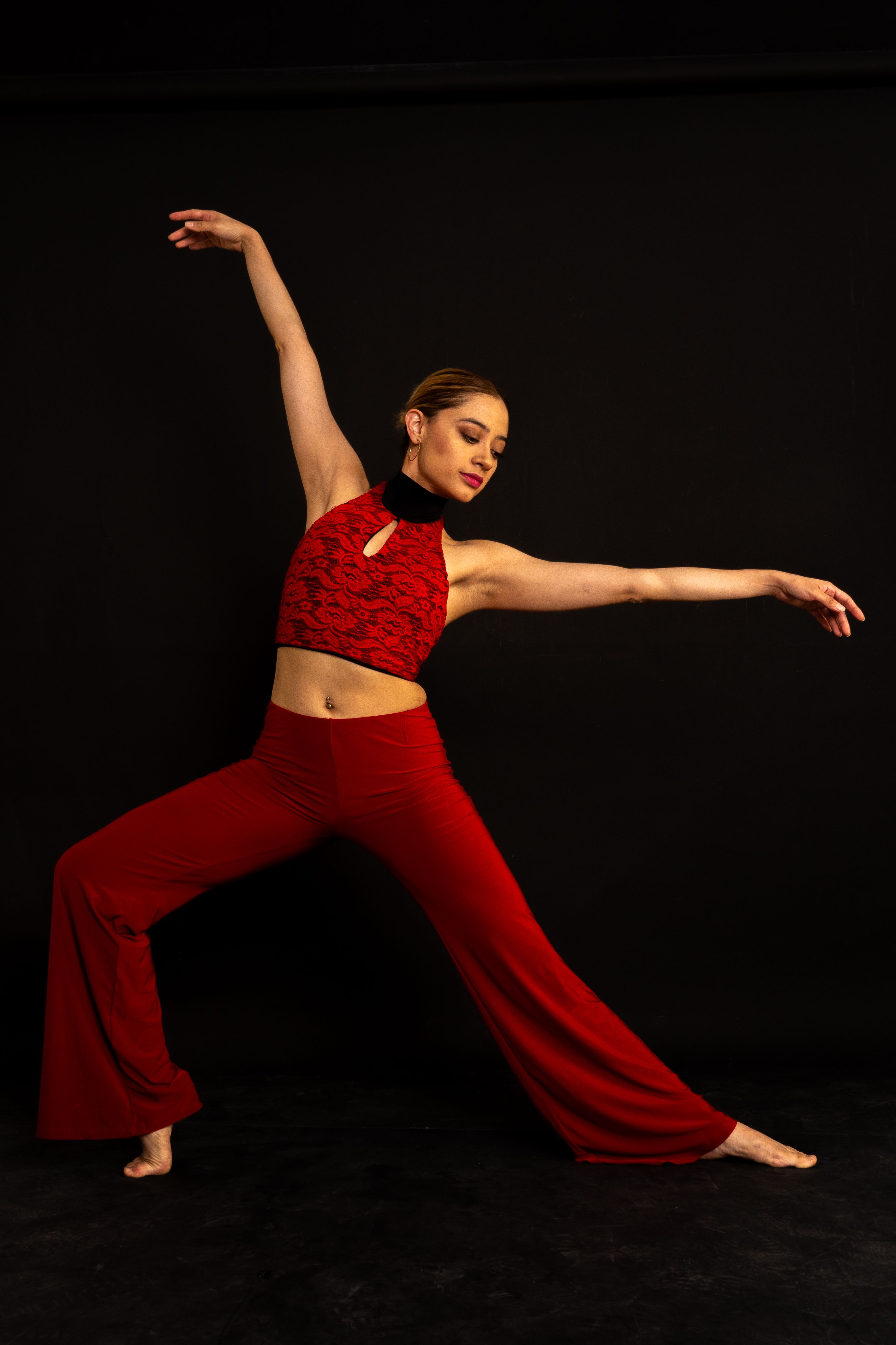 A Woman Wearing a Red Outfit Doing a Dance Pose · Free Stock Photo
