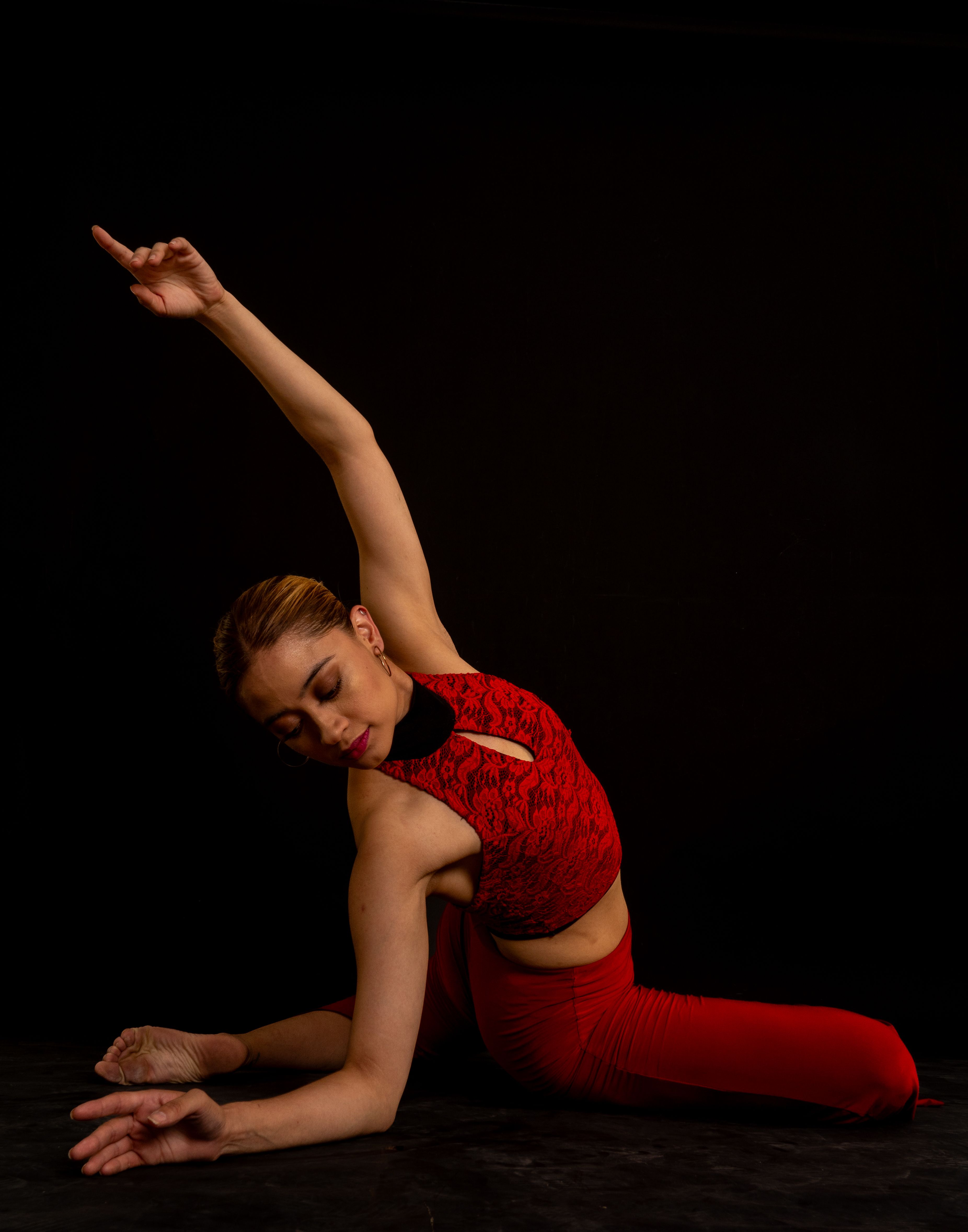 A Woman Wearing a Red Outfit Doing a Dance Pose · Free Stock Photo