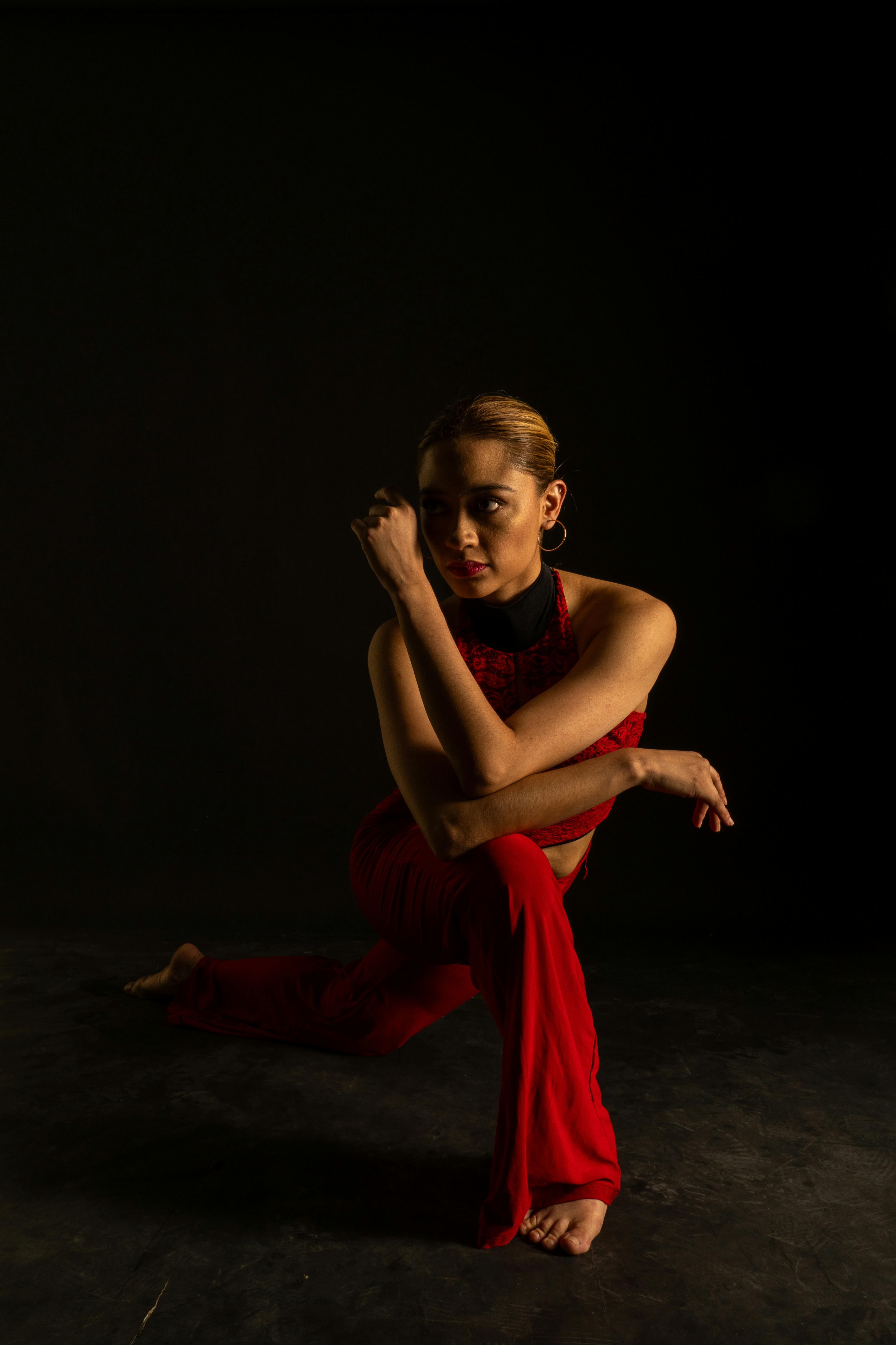 Dancer Crouching in Red Dress · Free Stock Photo