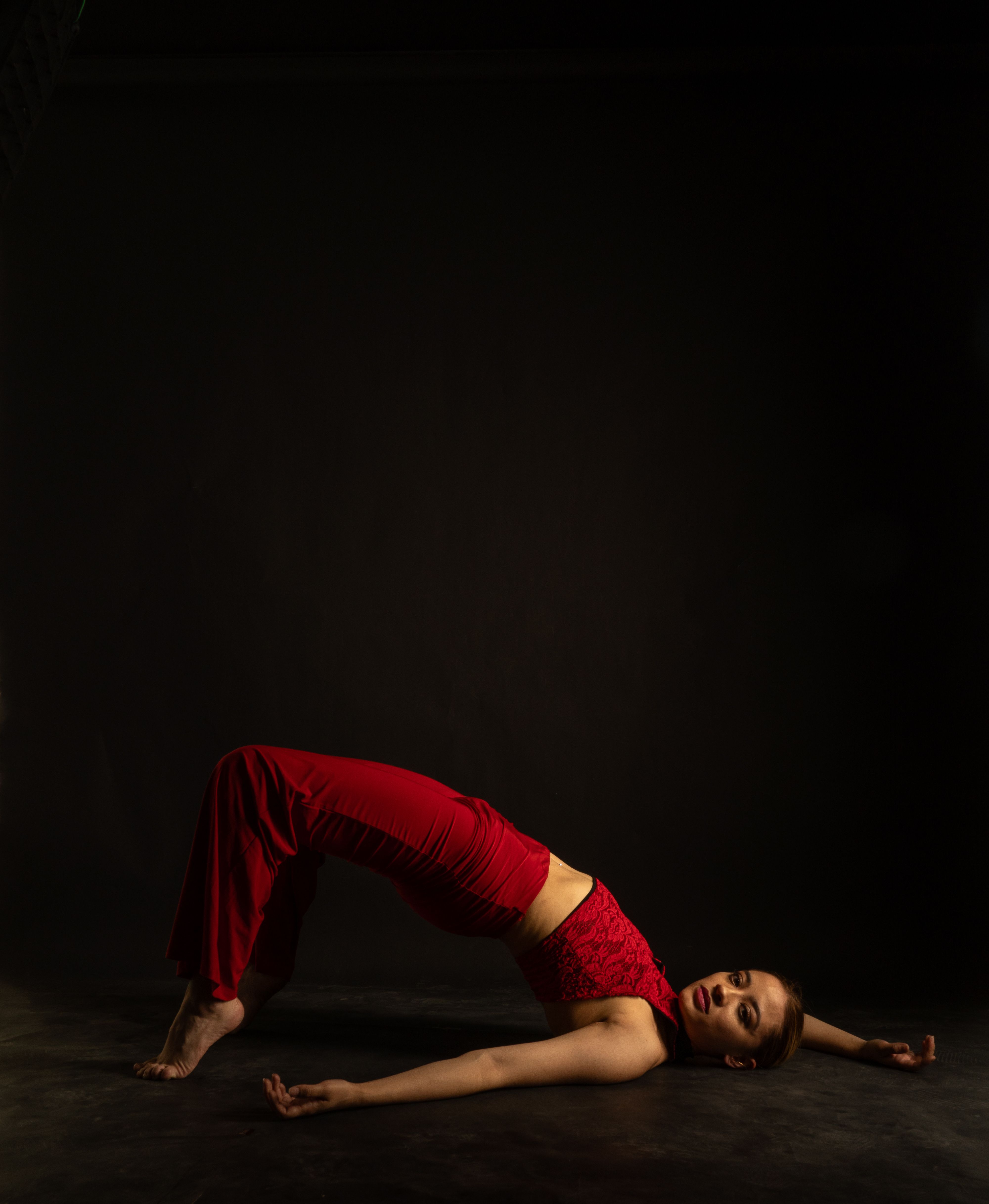 A Woman in a Red Outfit Doing a Dance Pose · Free Stock Photo