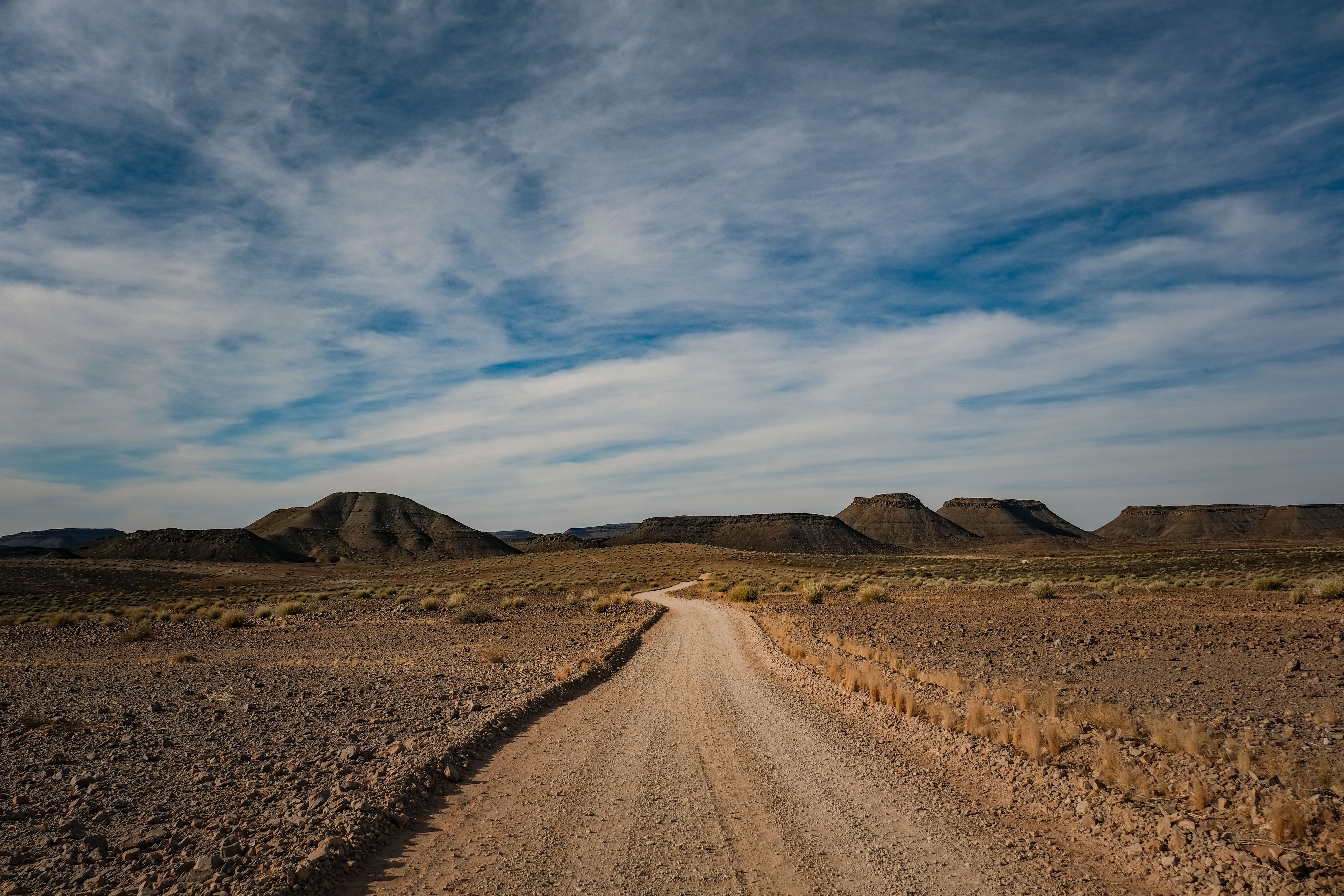 Dirt Road on Plains towards Hills · Free Stock Photo