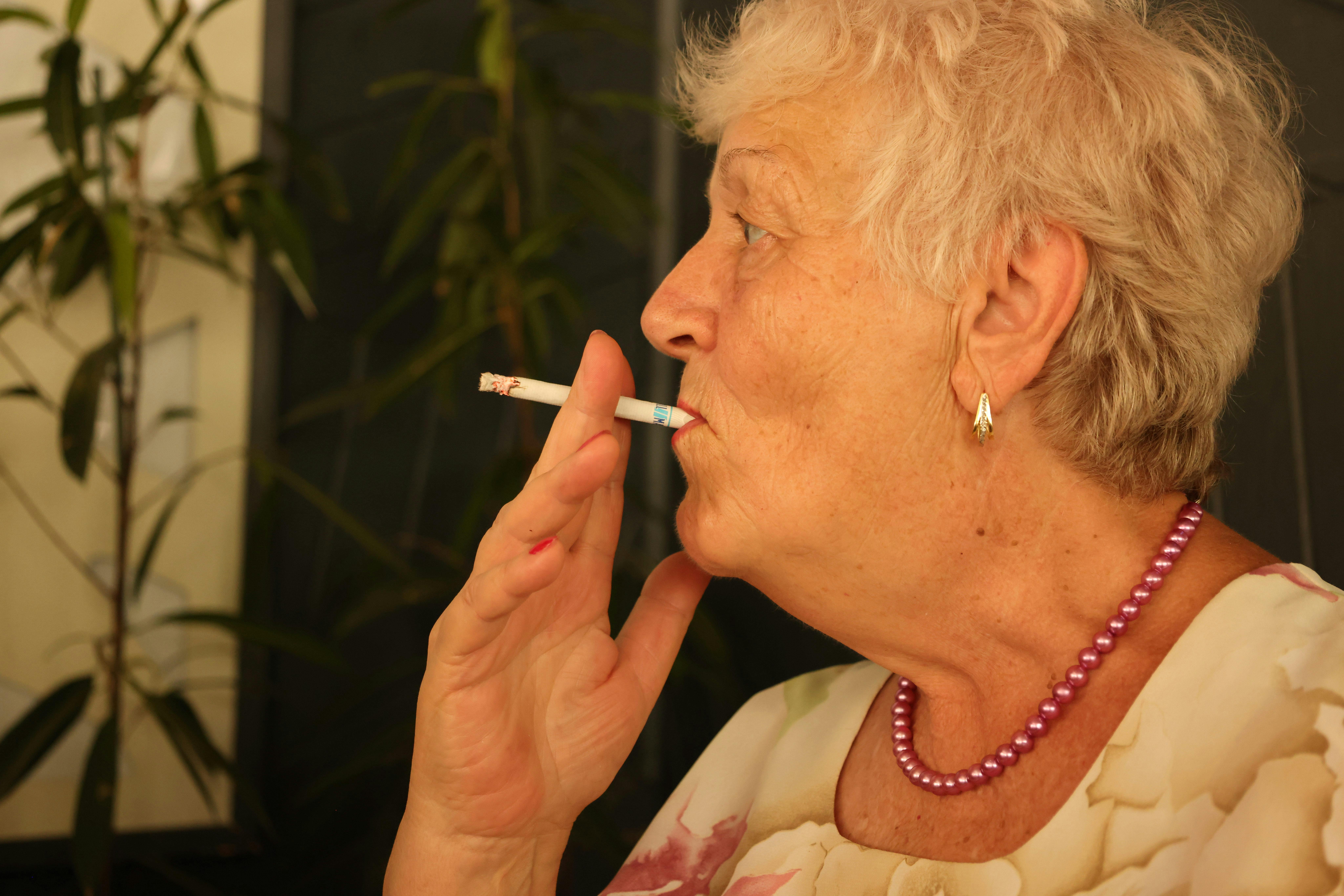 Elderly Woman Smoking Cigarette · Free Stock Photo