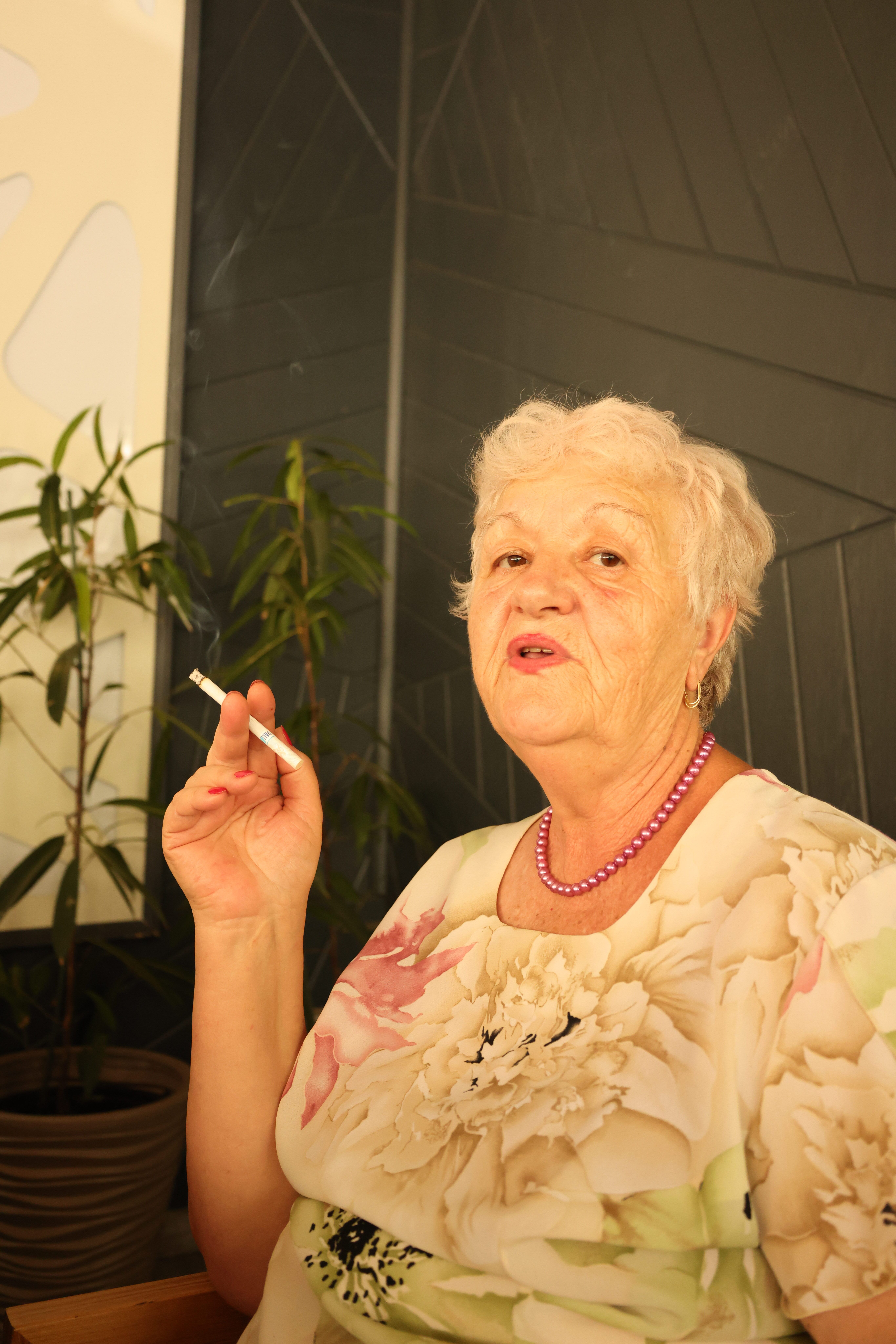 Elderly Woman Smoking a Cigarette · Free Stock Photo