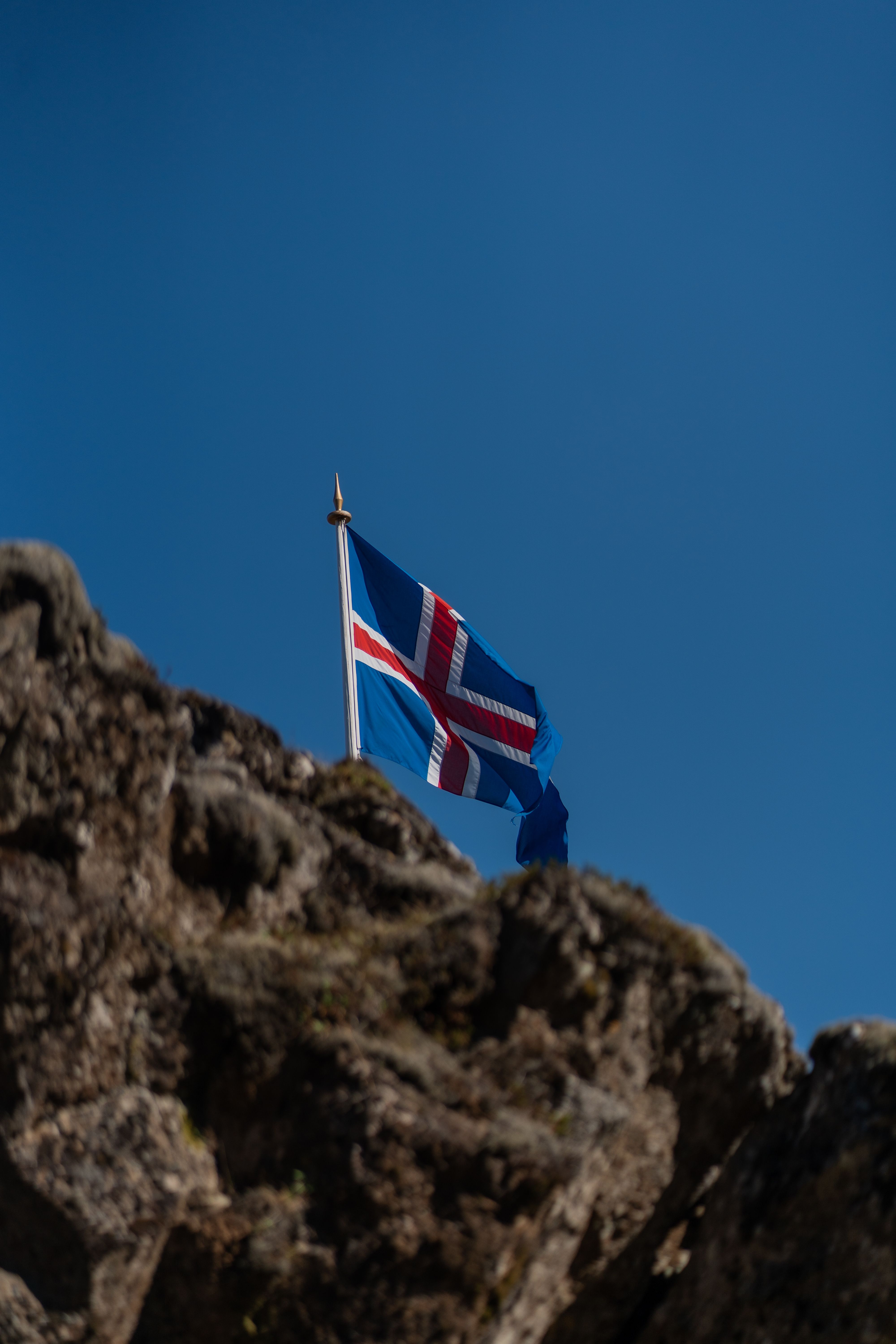 Flag of Island Among Rocks · Free Stock Photo