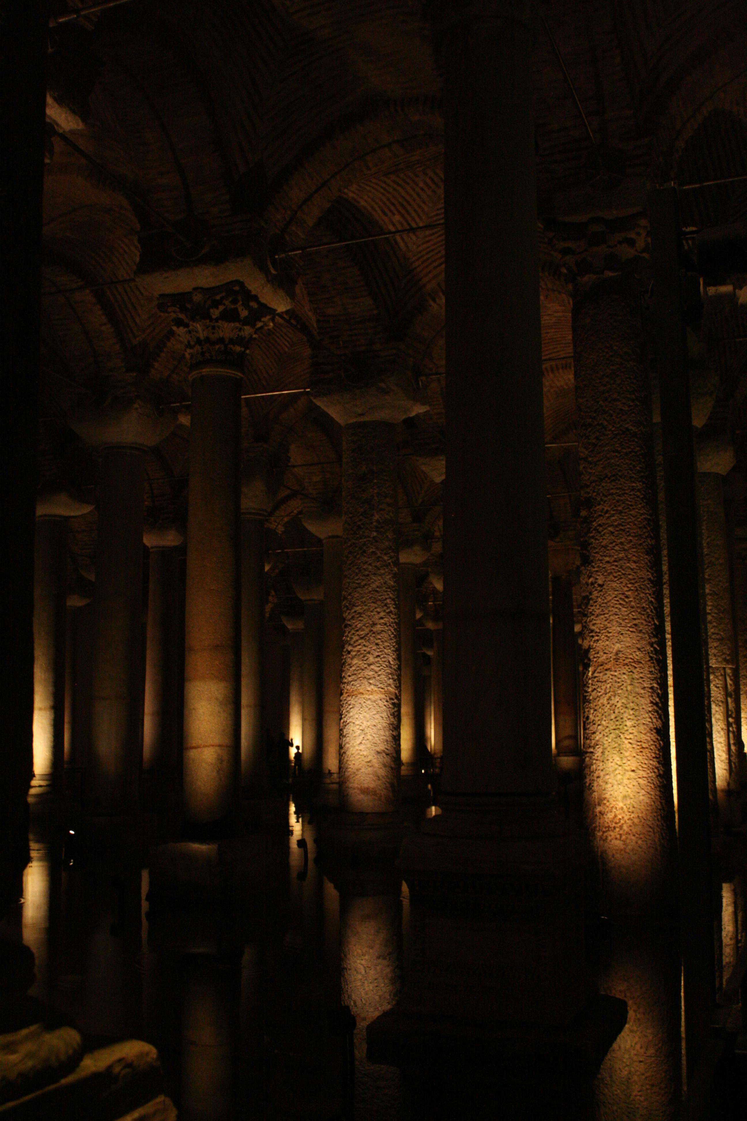 The inside of a large underground structure with columns · Free Stock Photo
