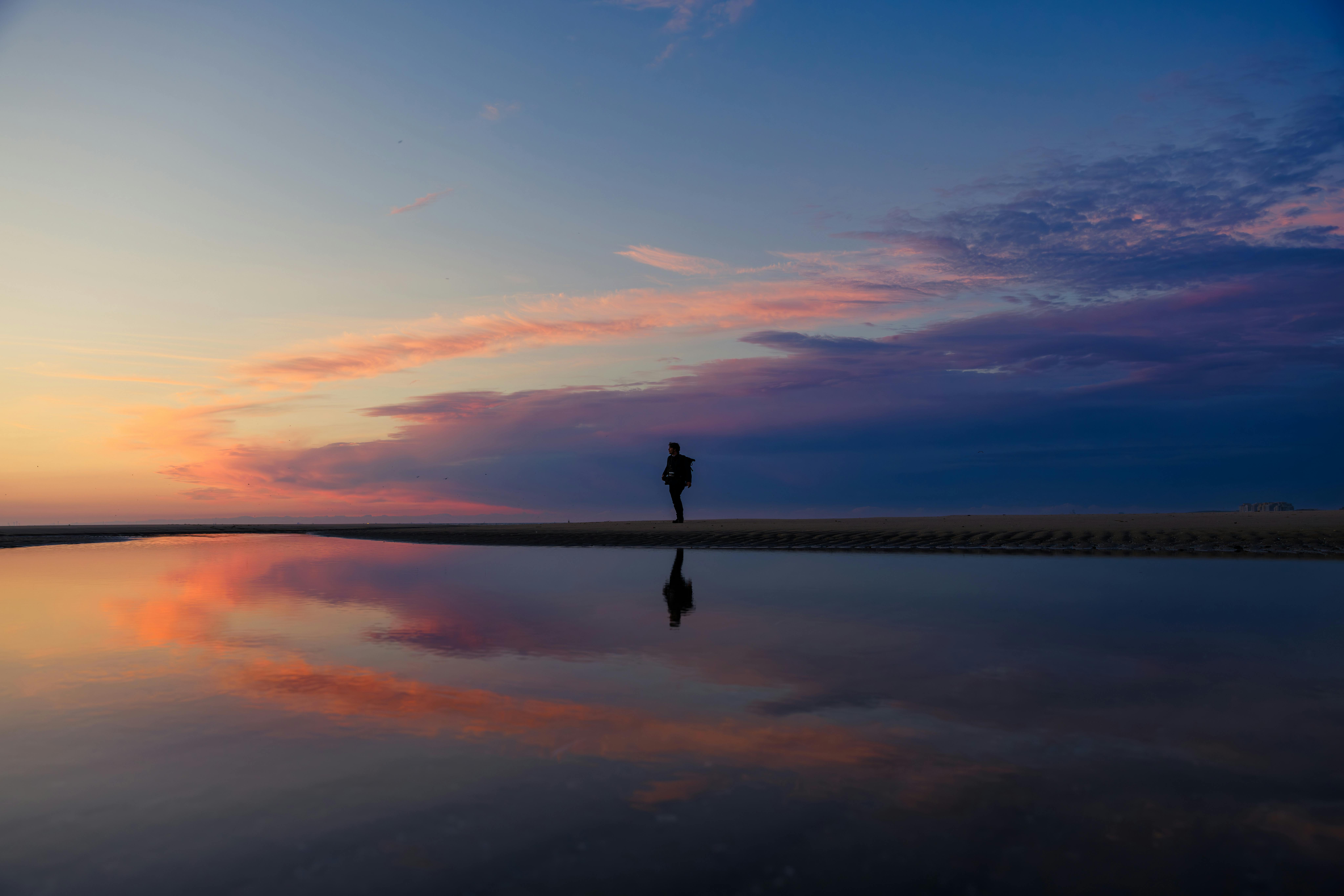 Person Standing on Sand · Free Stock Photo