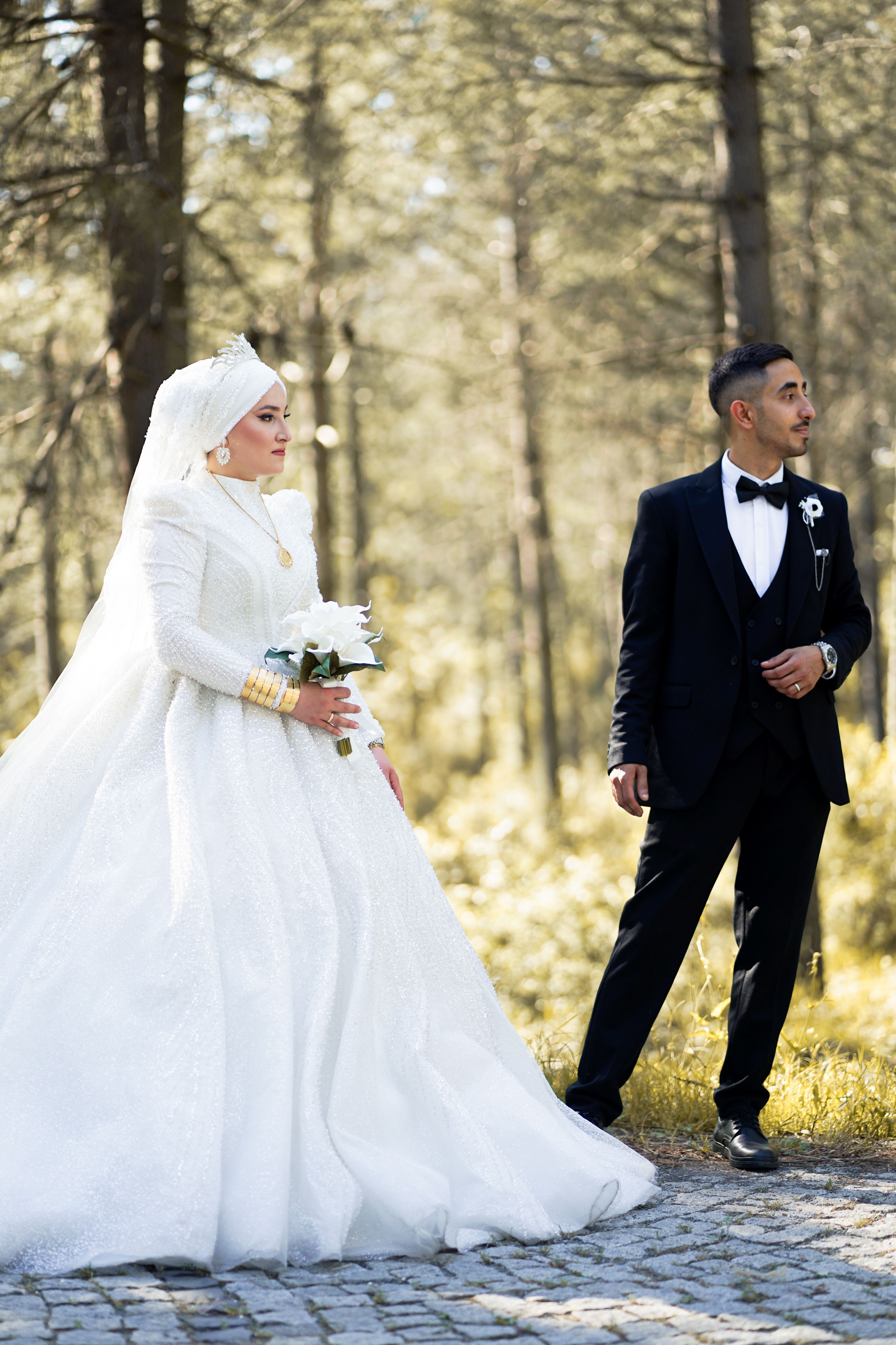 Bride and Groom in Wedding Clothing Posing on Pavement · Free Stock Photo