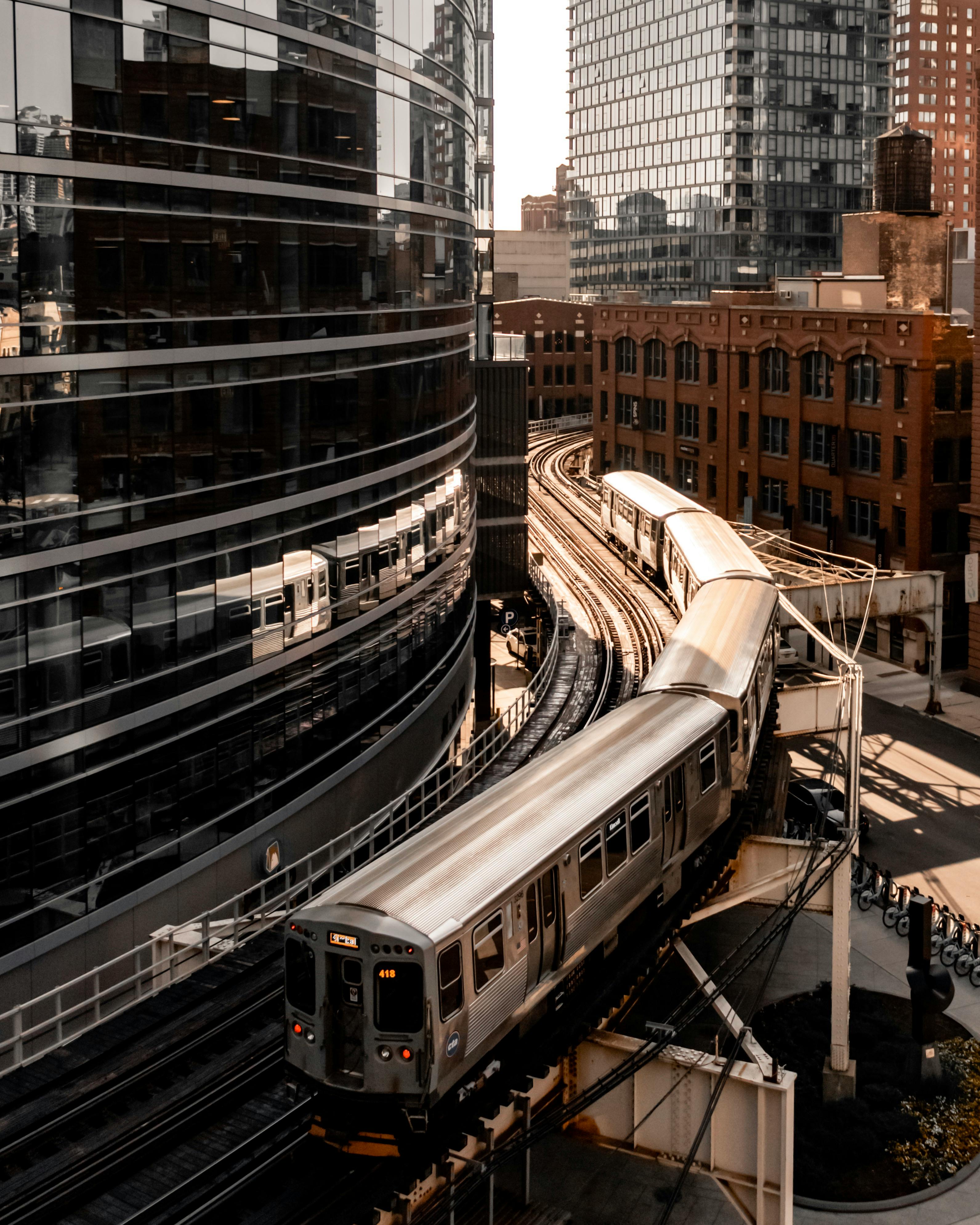 Photo of Grey Bridge Train Beside Glass Building · Free Stock Photo