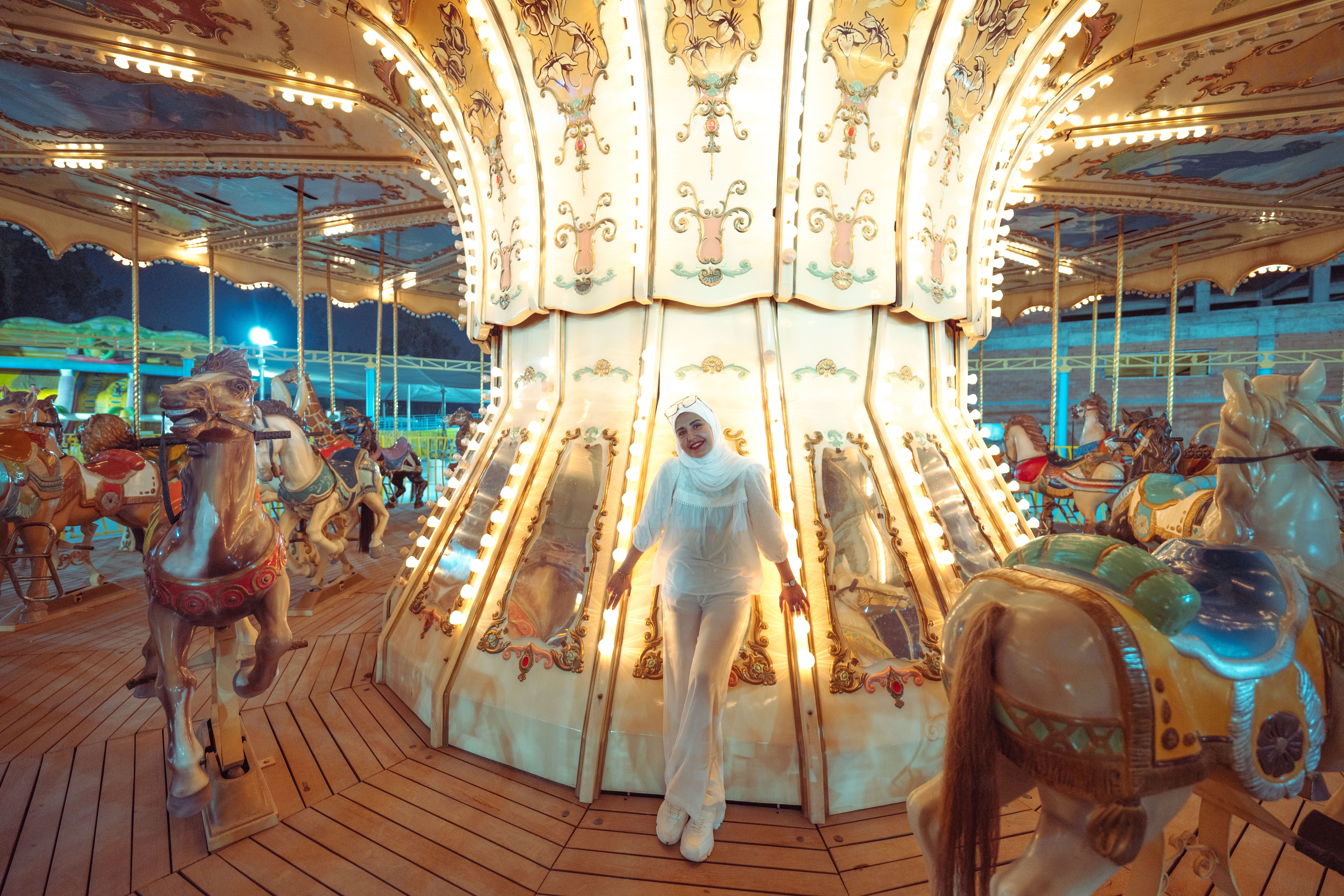 Woman in White Outfit Posing on Carousel · Free Stock Photo