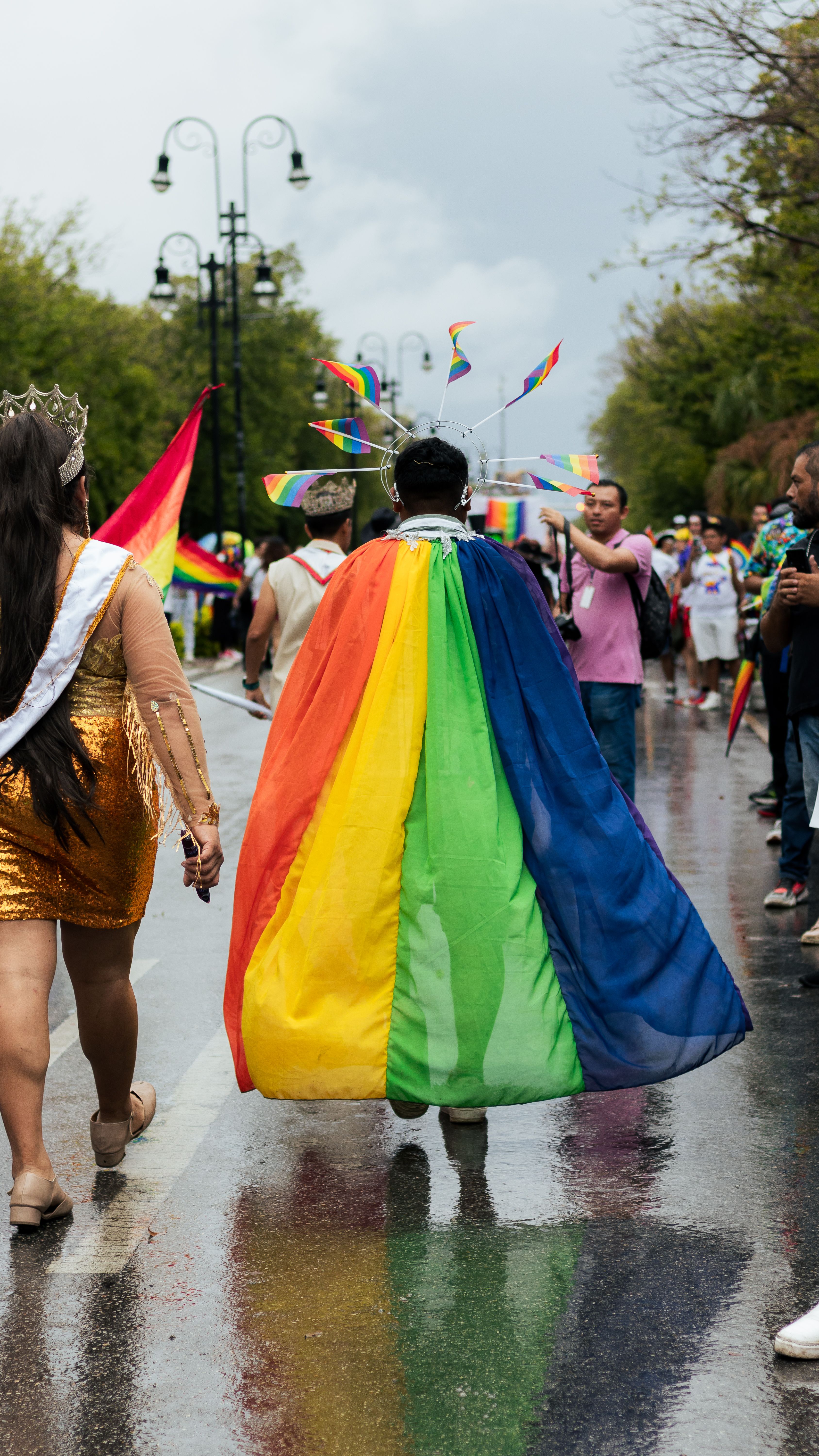 Person in Cape and Halo Crown with LGBT Flags at the Pride Parade ...