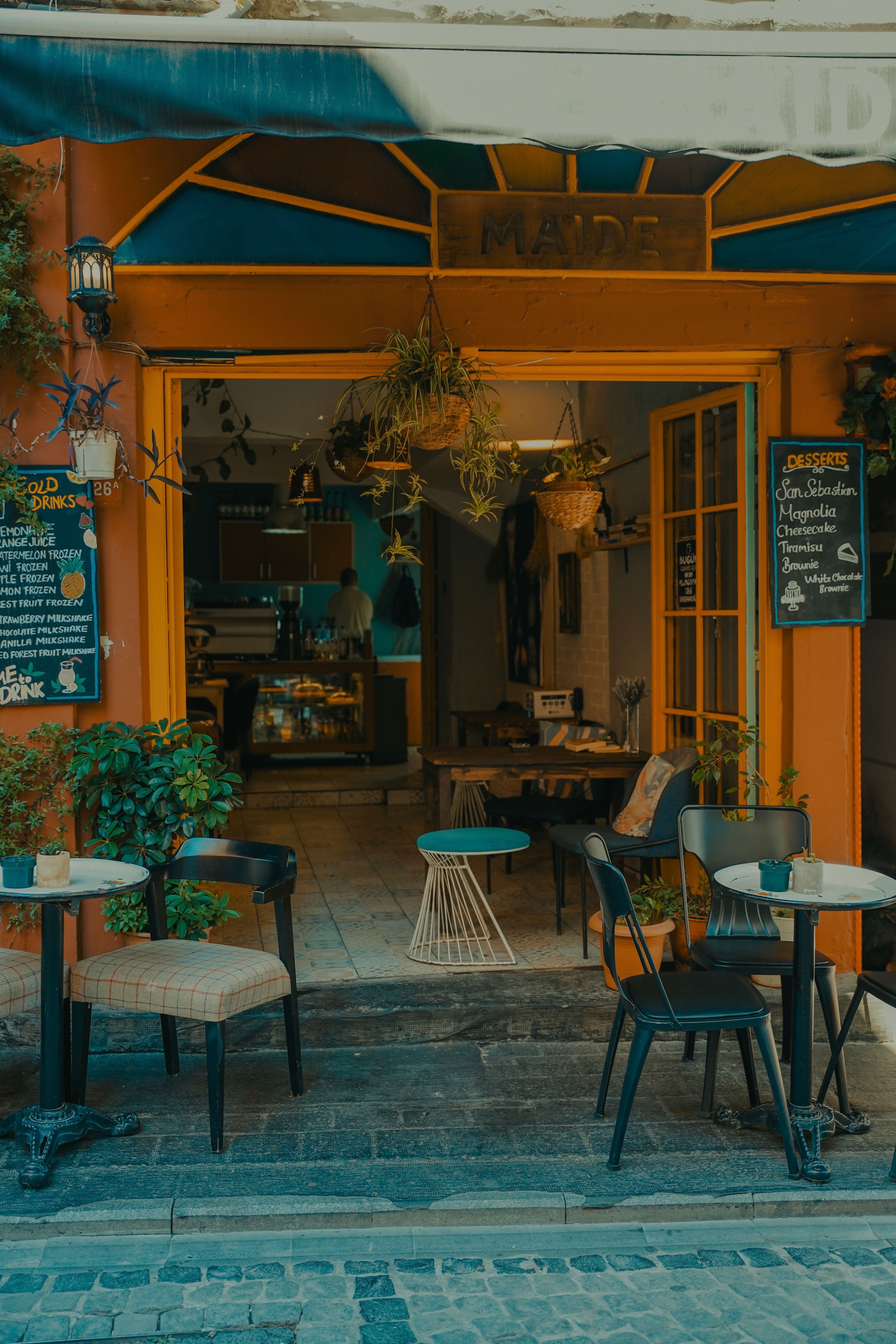 Charming Outdoor Café with Floral Decor · Free Stock Photo