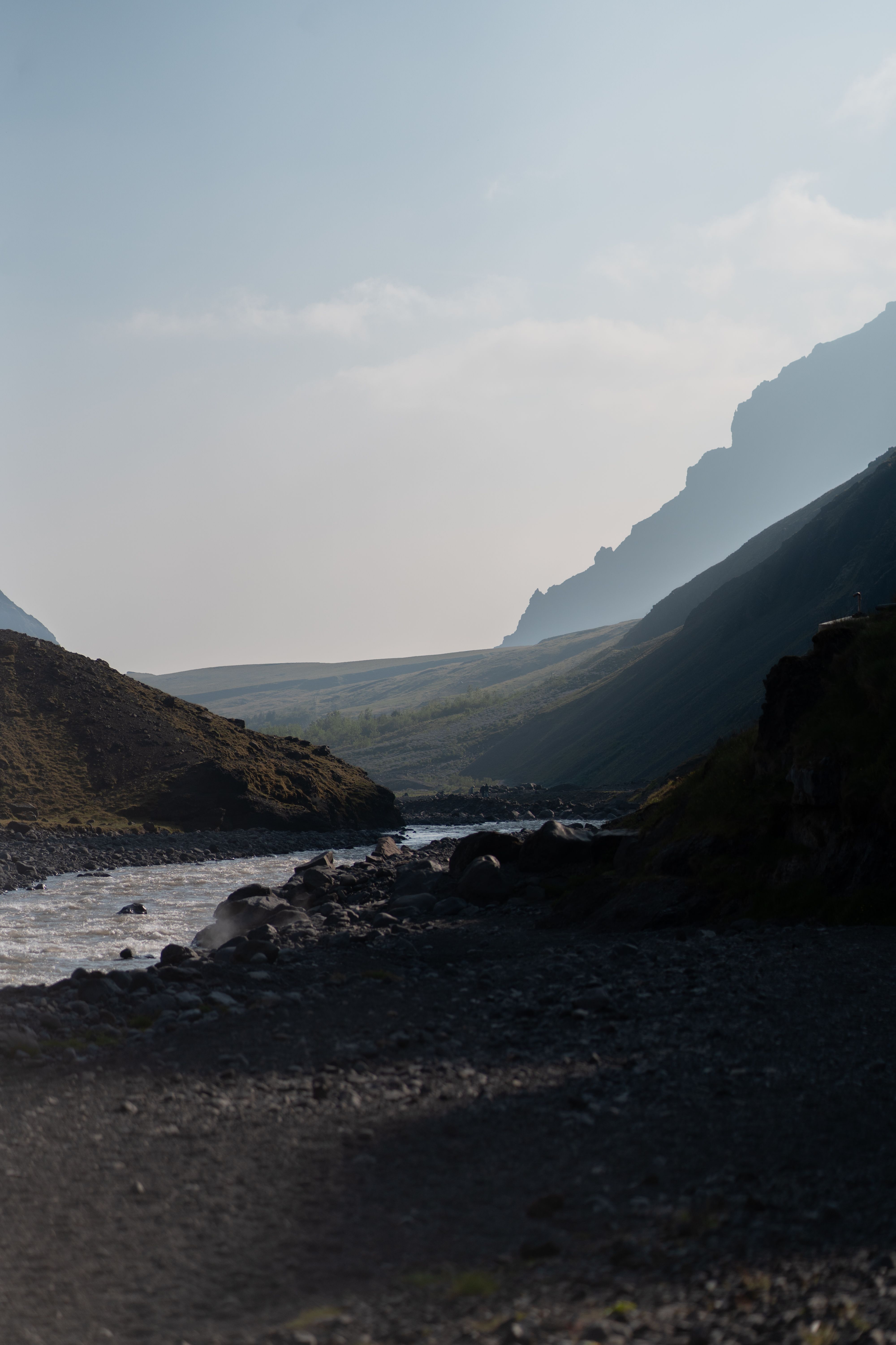 A person standing on a rock in front of a river · Free Stock Photo