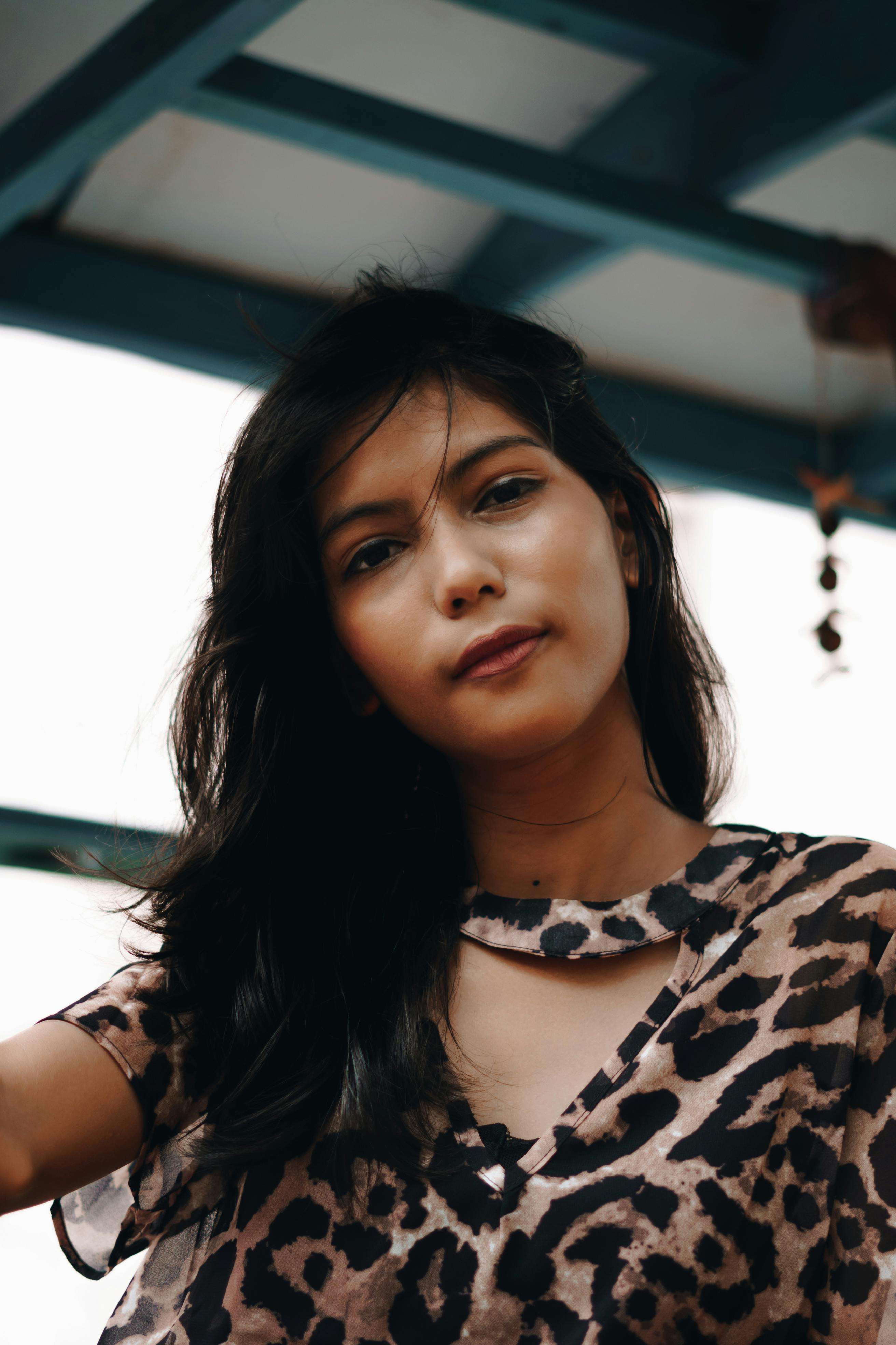 Photo of Woman Sitting Near Roller Shutter · Free Stock Photo