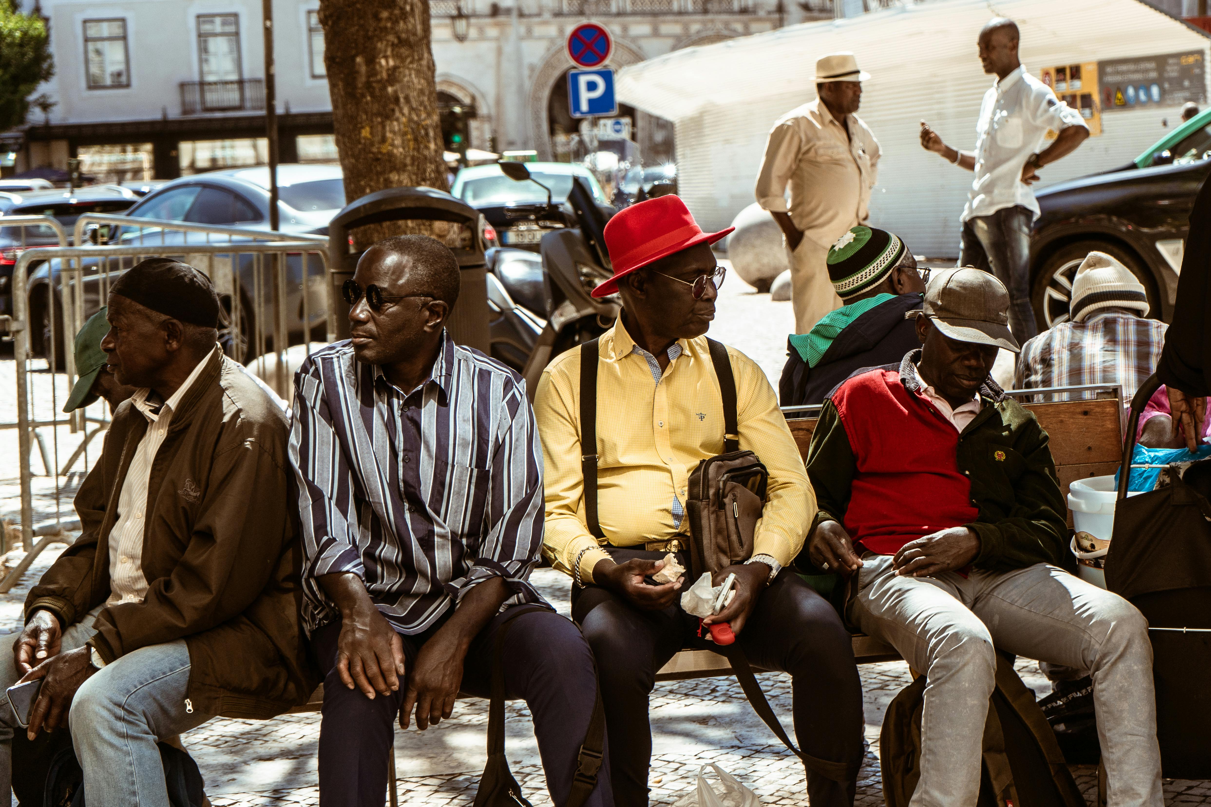 Group of Men Resting on a Bench · Free Stock Photo