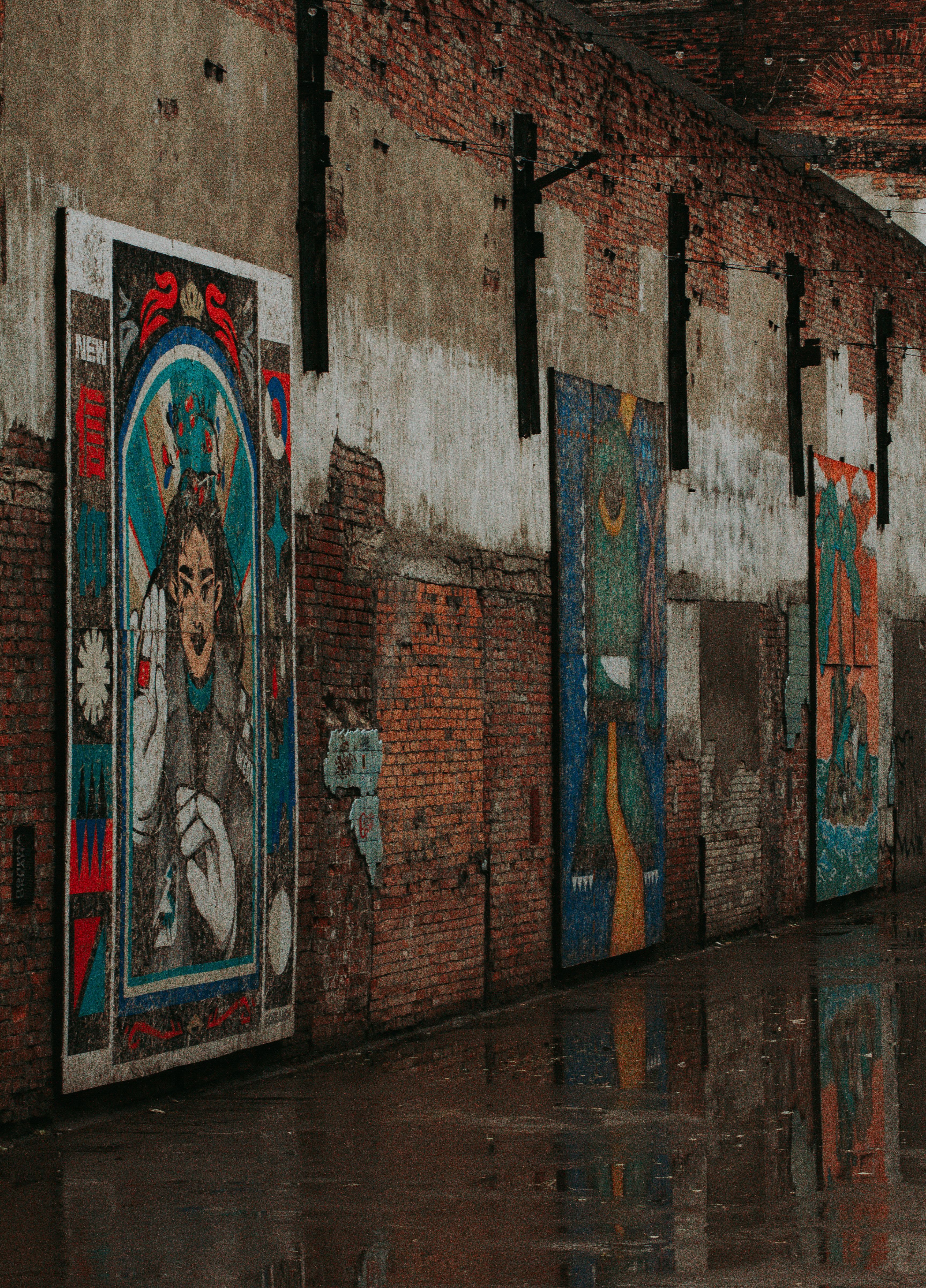 Murals on Old Brick Wall in City · Free Stock Photo