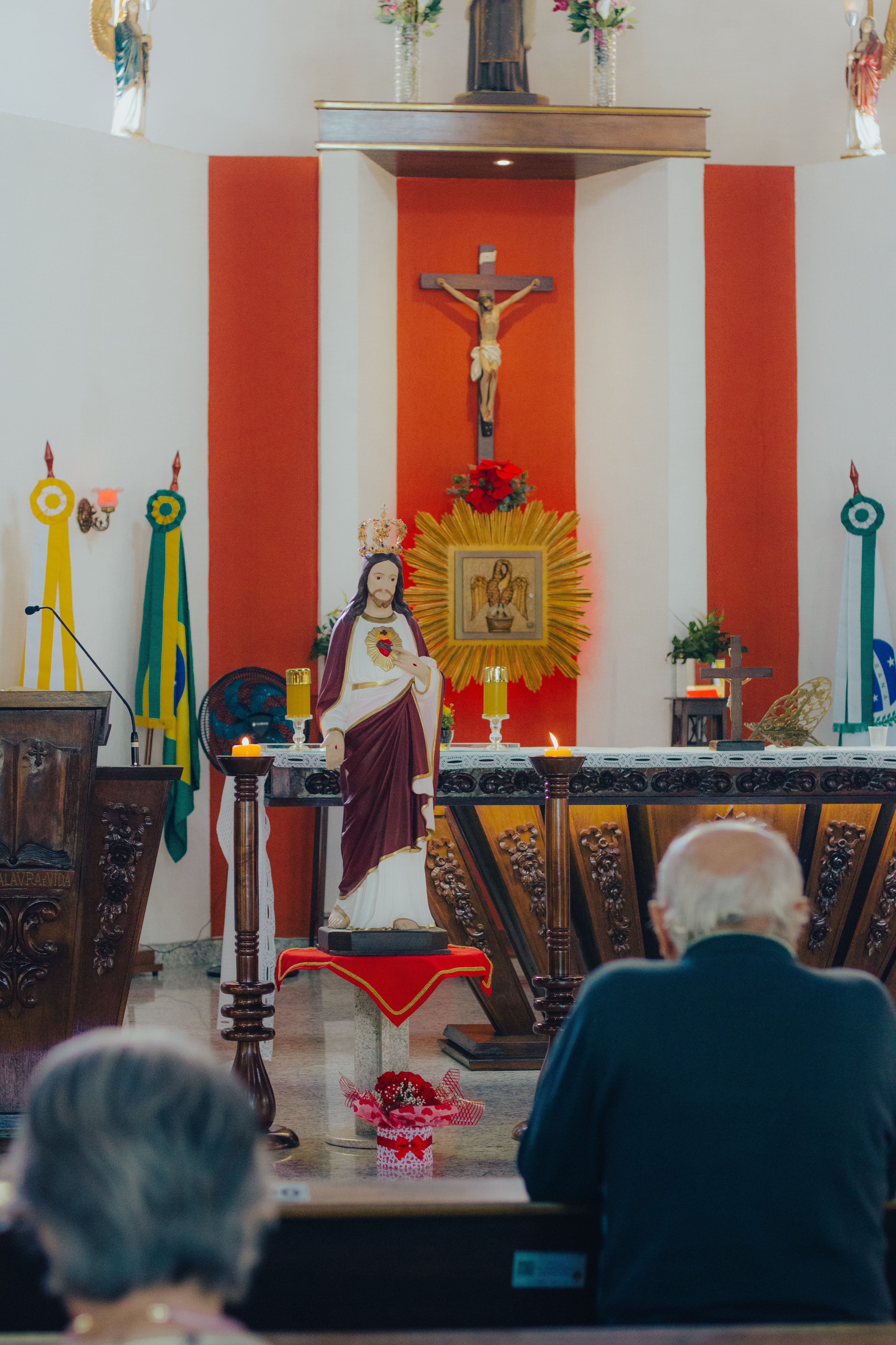 A priest is standing at the altar in a church · Free Stock Photo