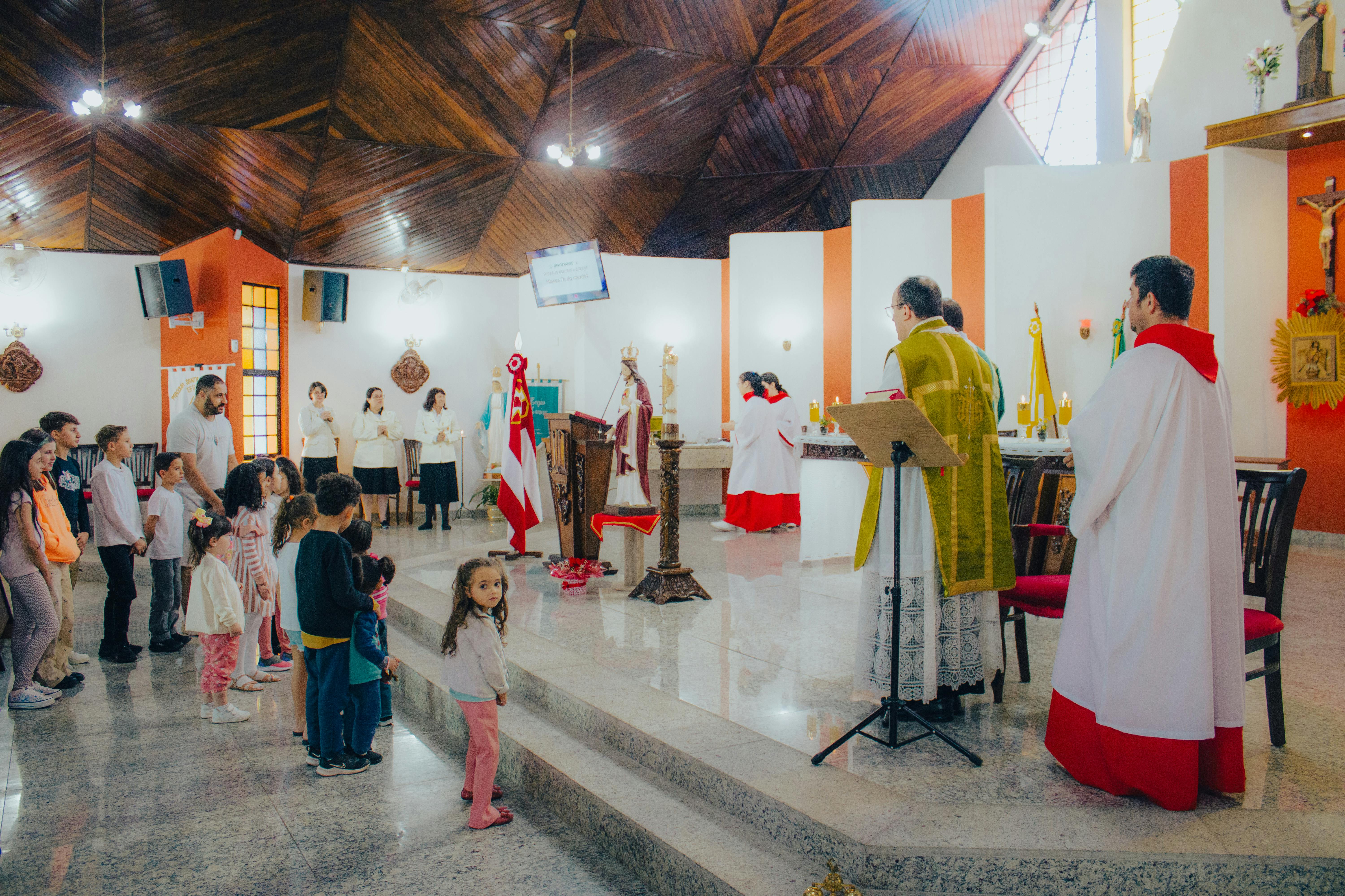 A priest and children in a church · Free Stock Photo
