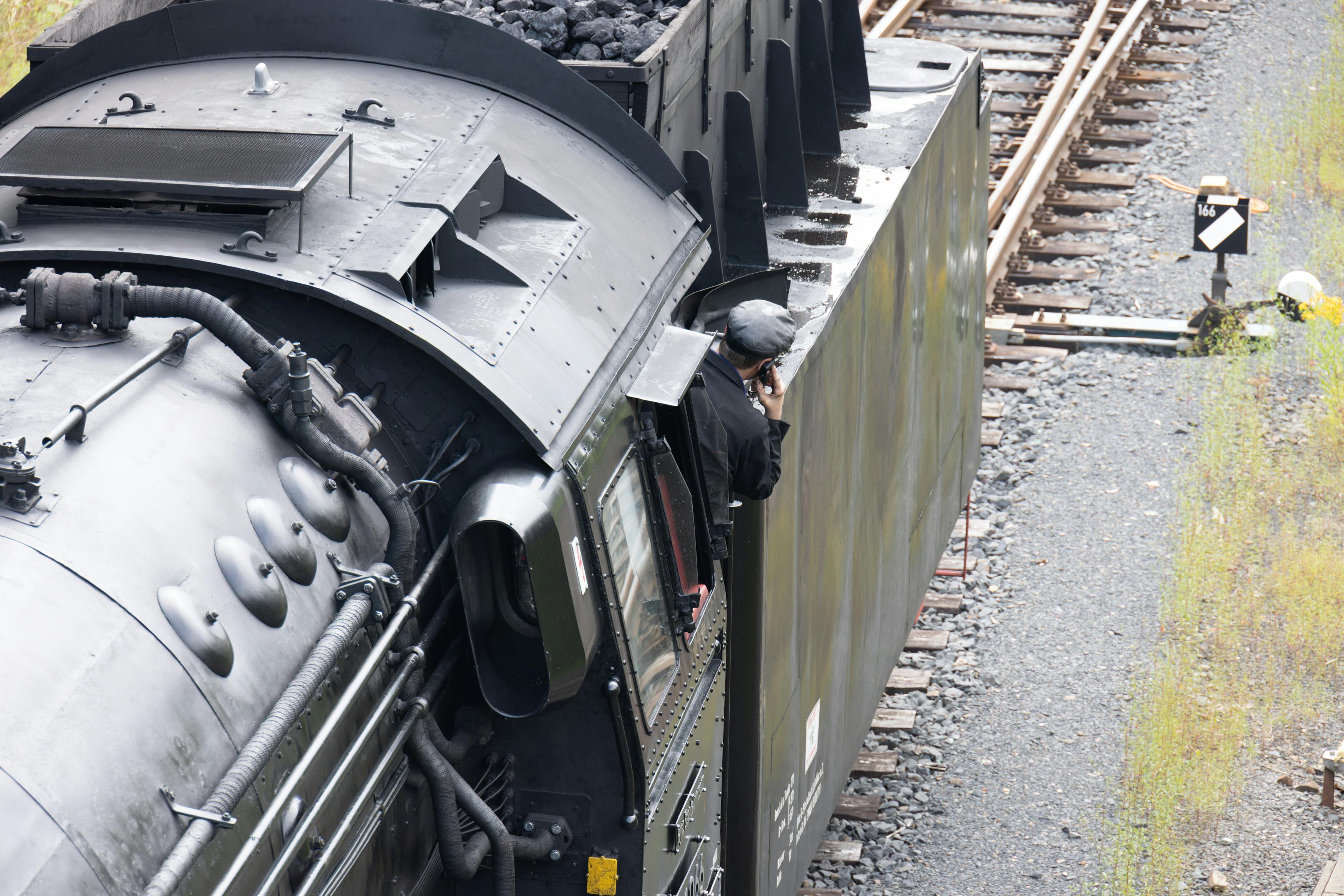 Steam Locomotive Engineer Talking on a Phone · Free Stock Photo