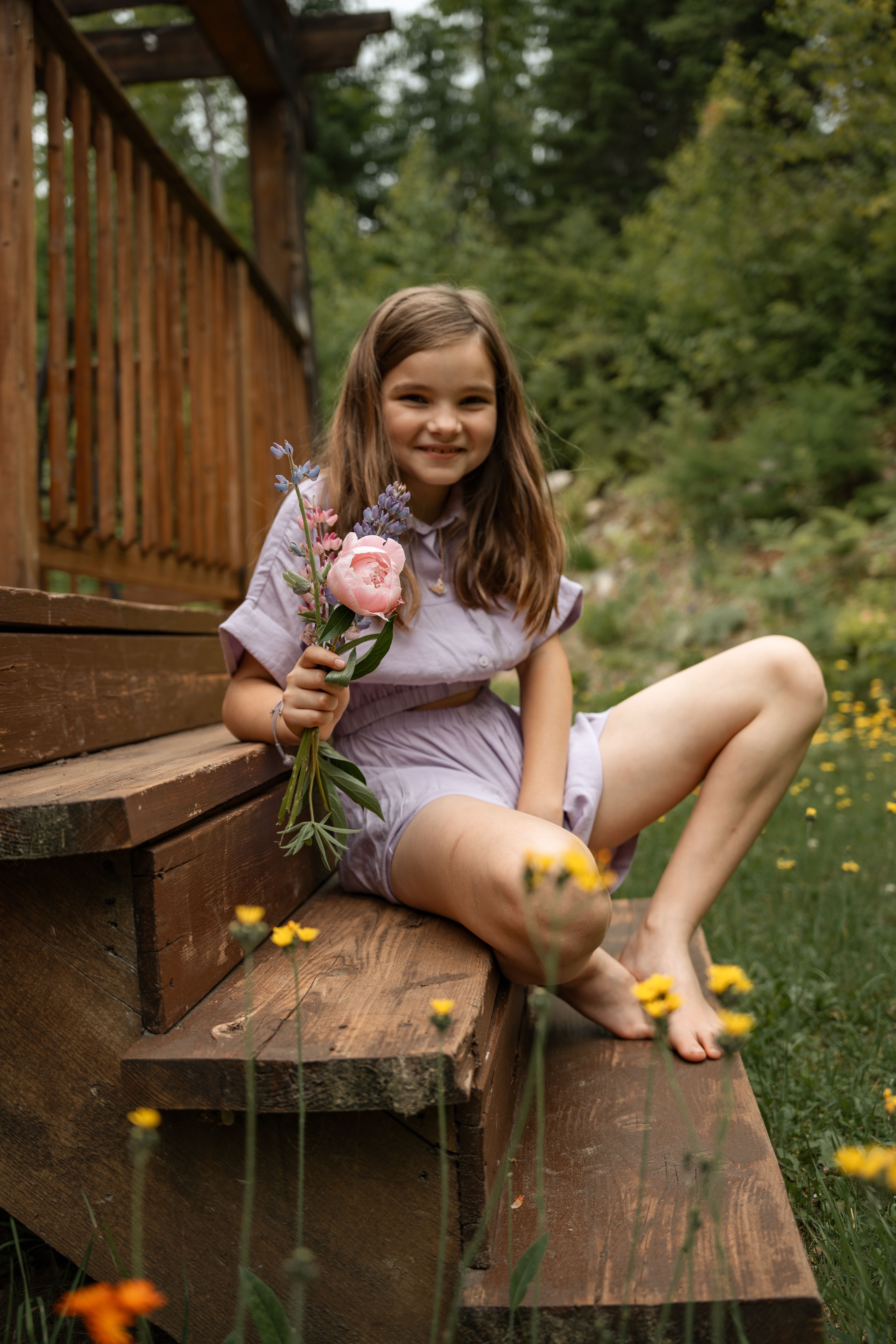Smiling Girl Sitting with Flowers · Free Stock Photo