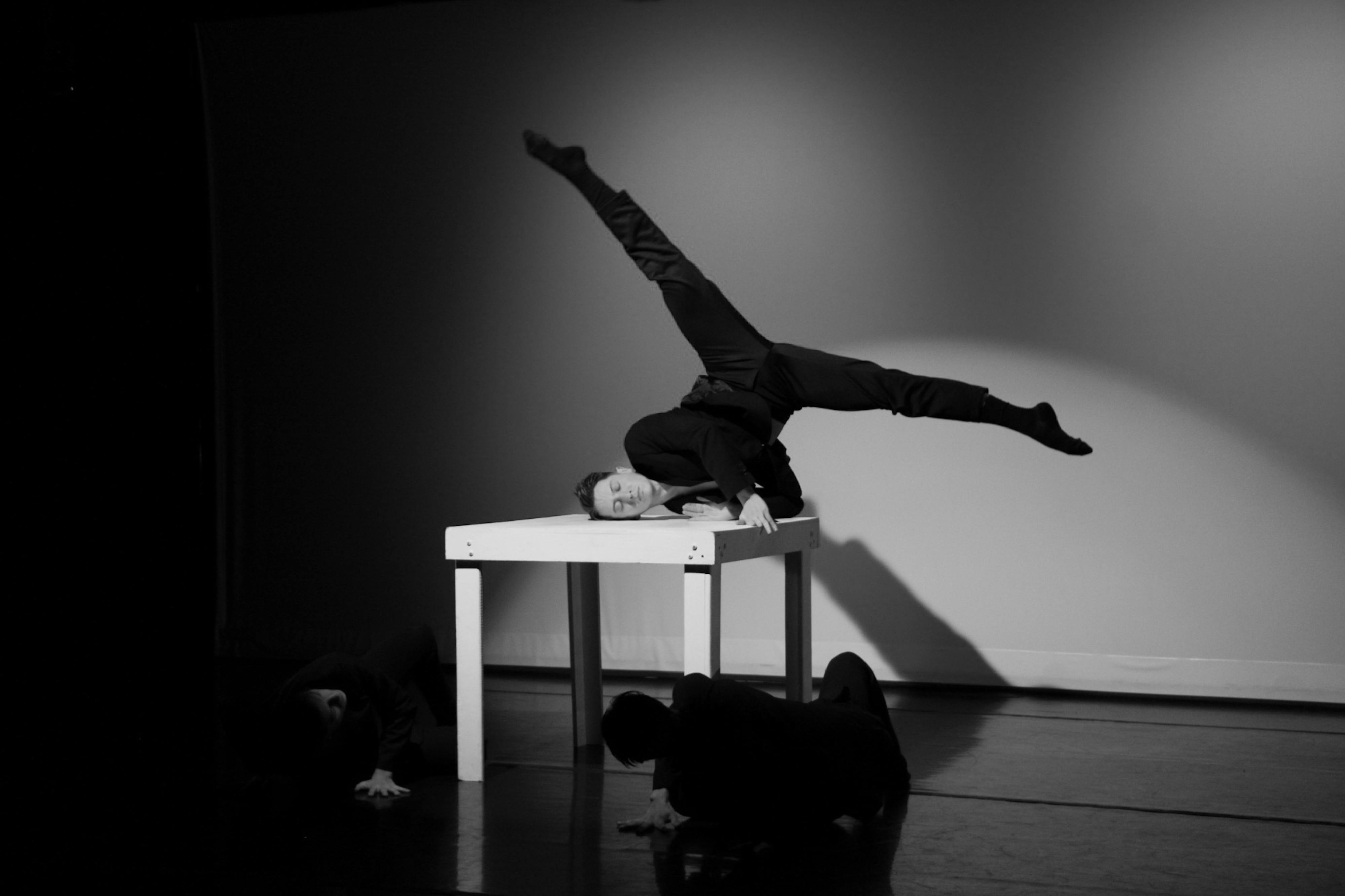 A man doing a handstand on a table · Free Stock Photo